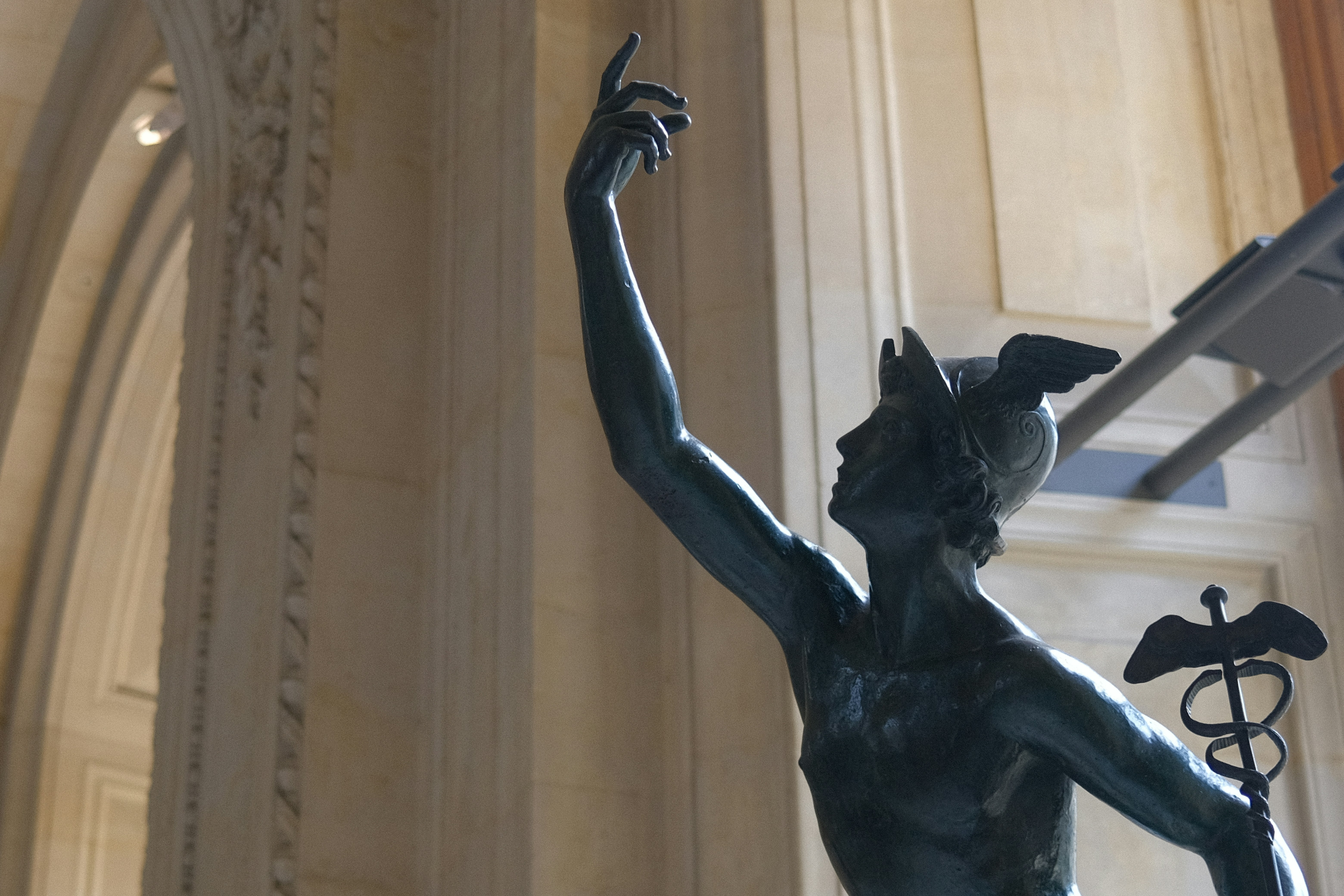 Bronzed Gesture: A Lithe Figure Reaches Toward the Ceiling