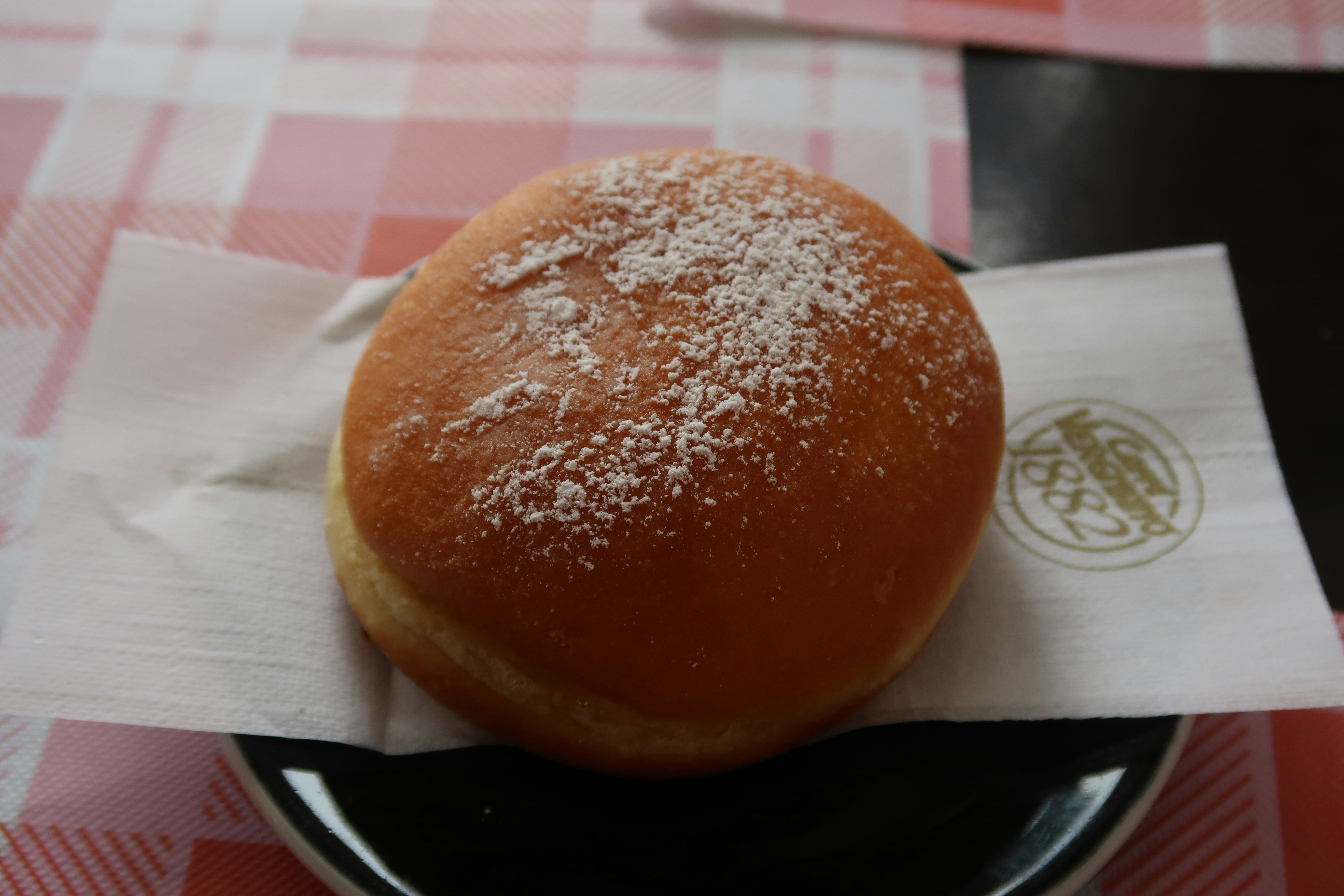 Powdered Ring: a sugared donut on a napkin-topped plate