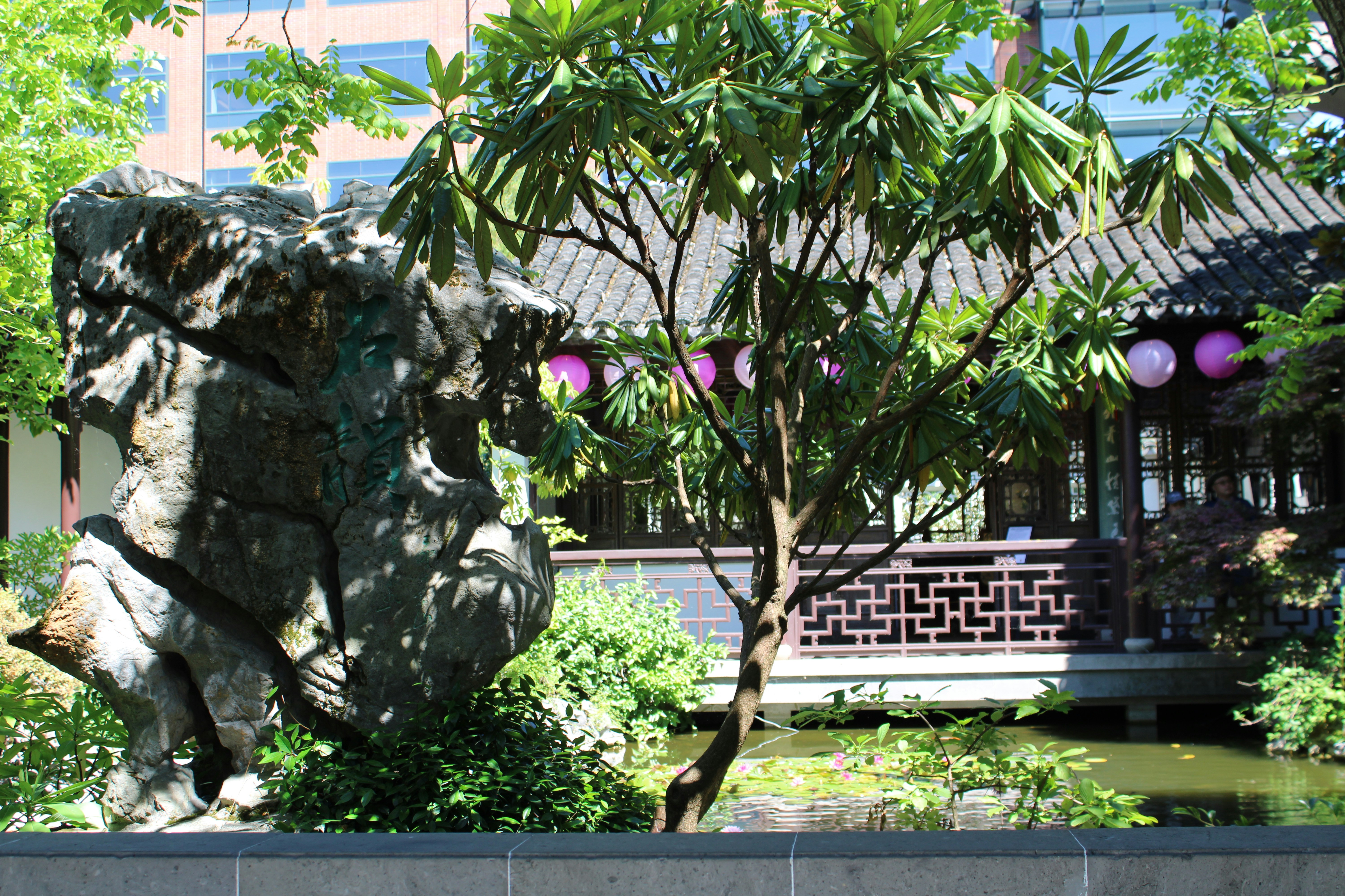 Quiet Courtyard with Stone Monument and Lantern-Bordered Pavilion