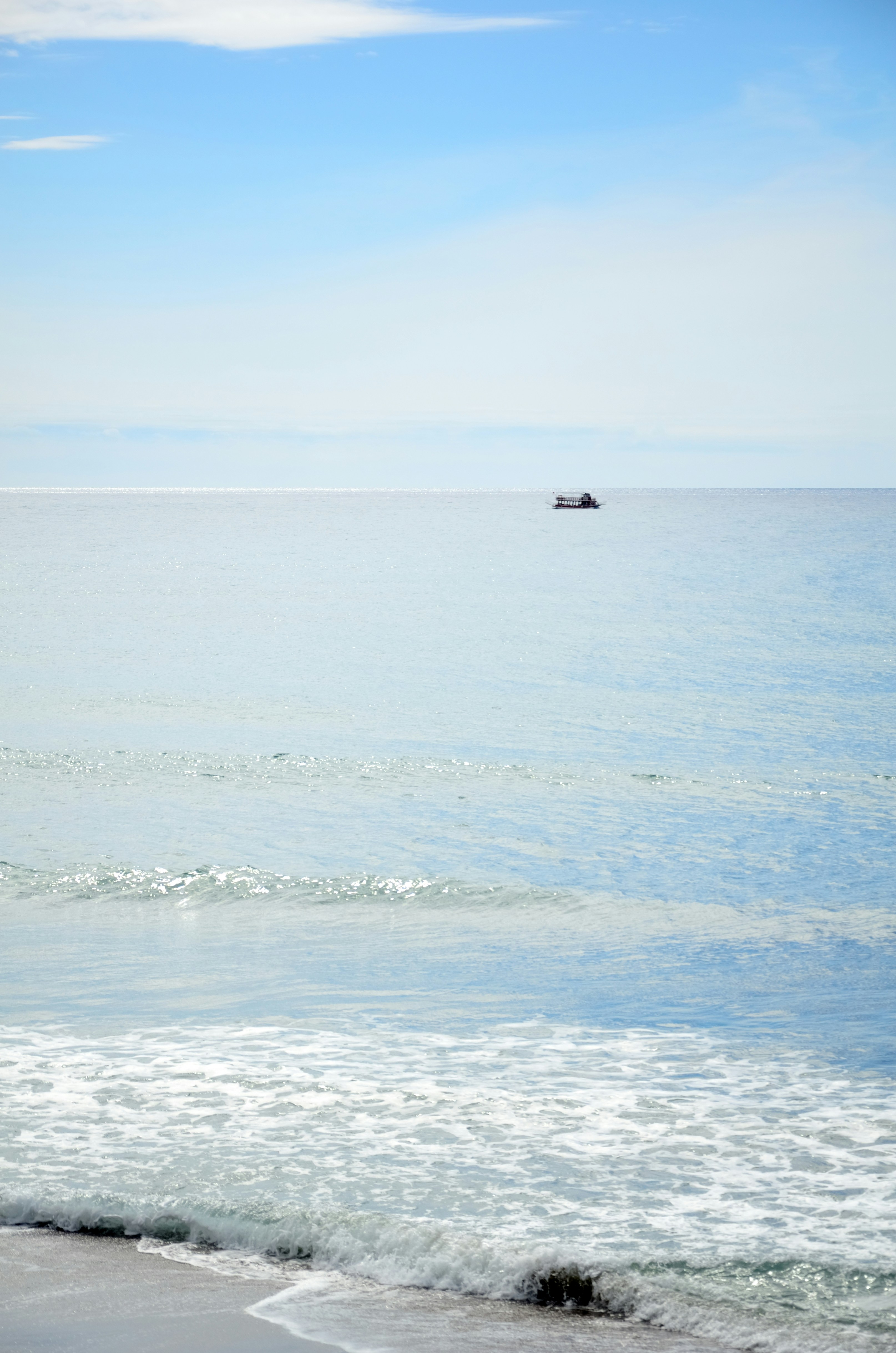 Horizon Vessel: A Lone Boat on a Quiet Sea