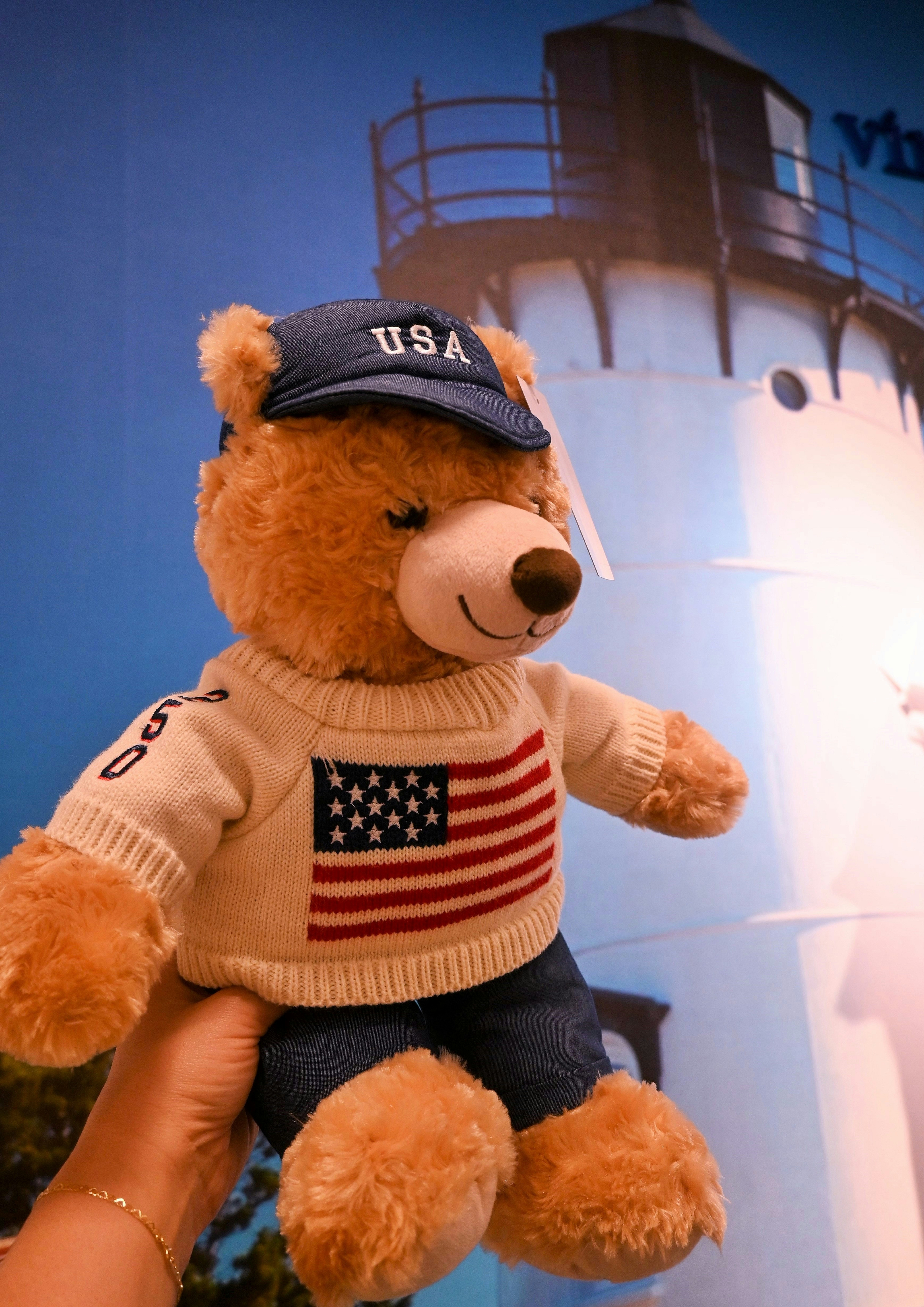 USA Teddy in Front of a Blue Lighthouse Backdrop