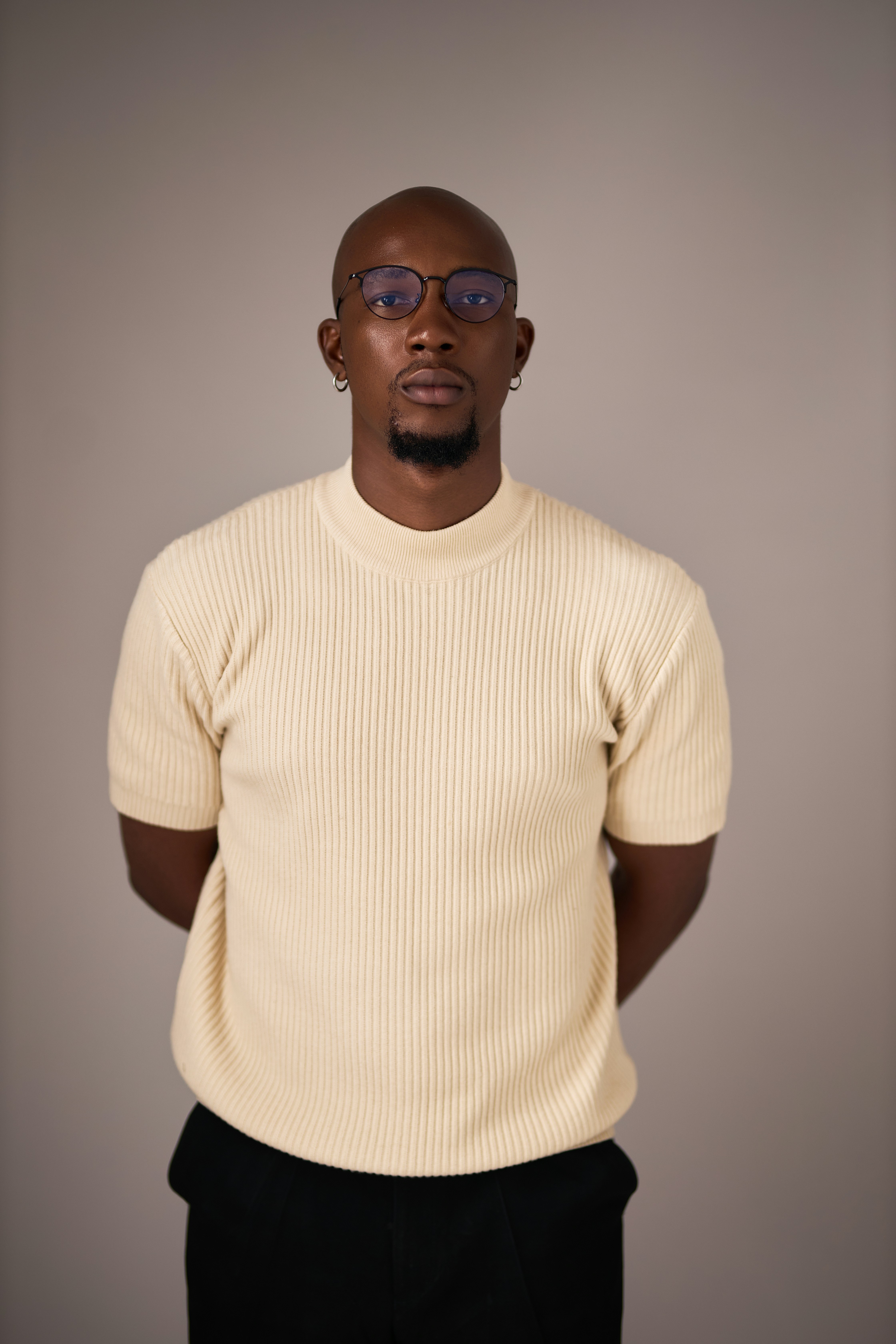 Portrait in Neutral Light: A Confident Stance in Cream Knit