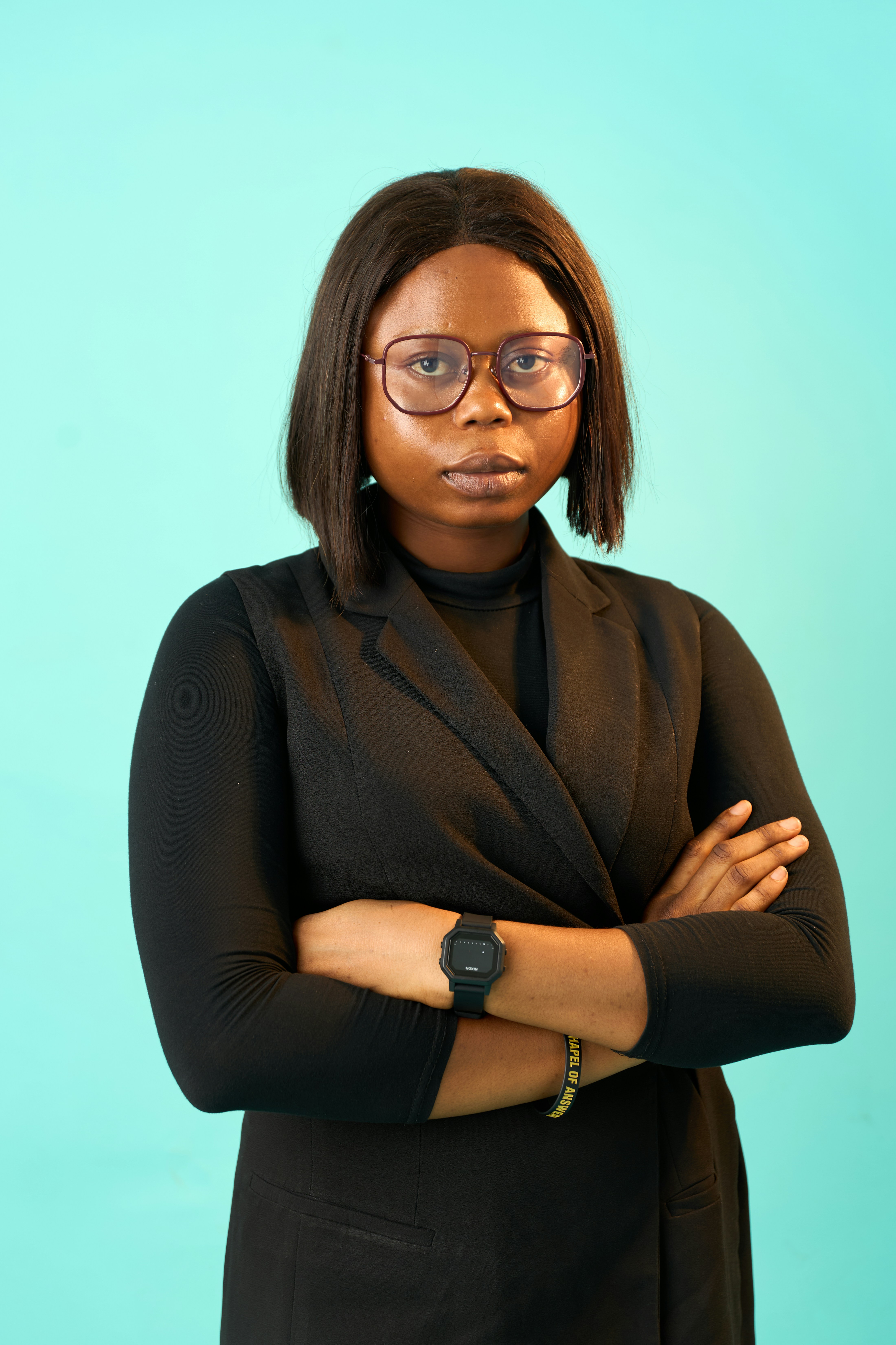 Confident Portrait: A Calm, Assertive Gaze Against Teal Backdrop