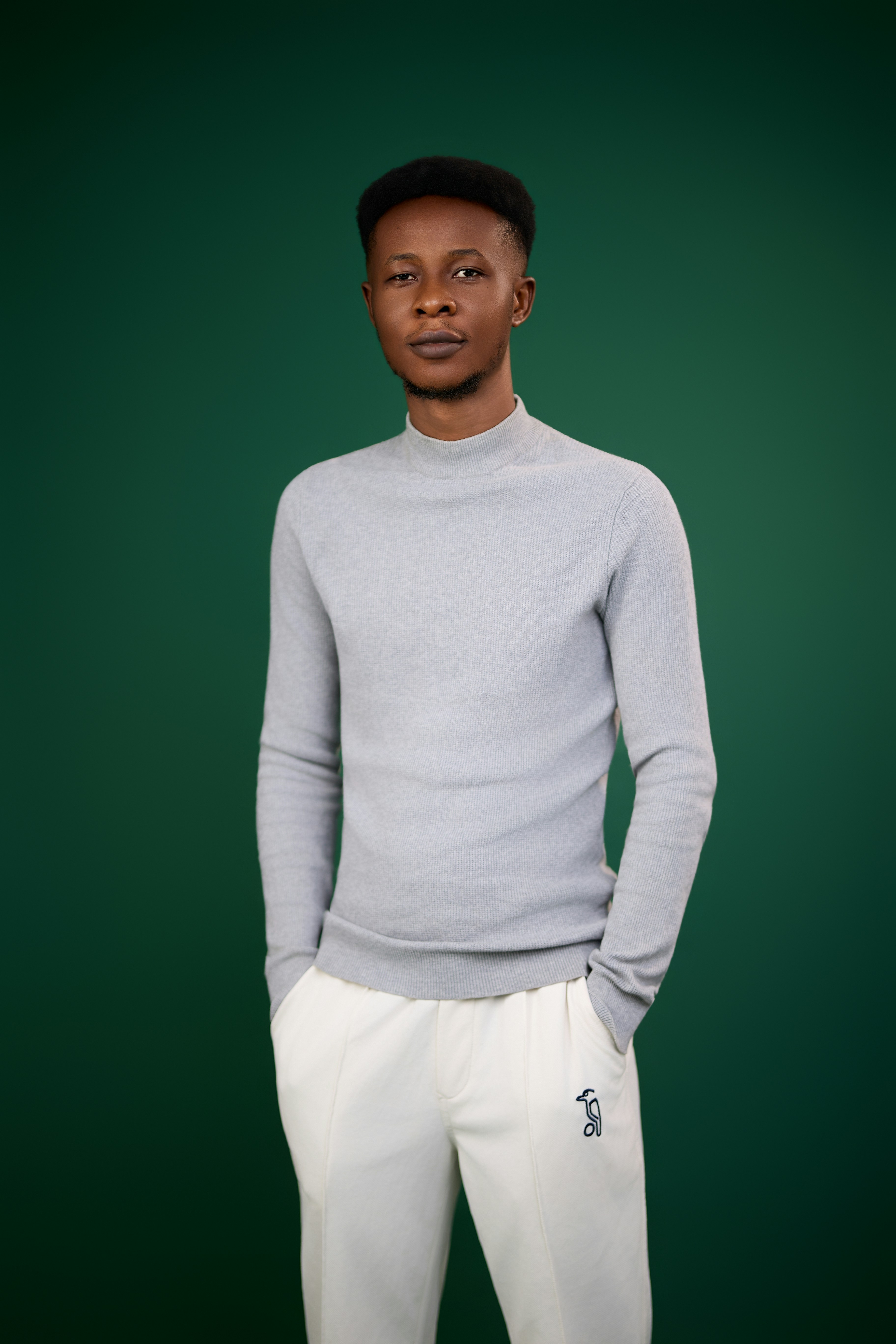 Neutral Green Studio: A Confident Pose in Soft Grey