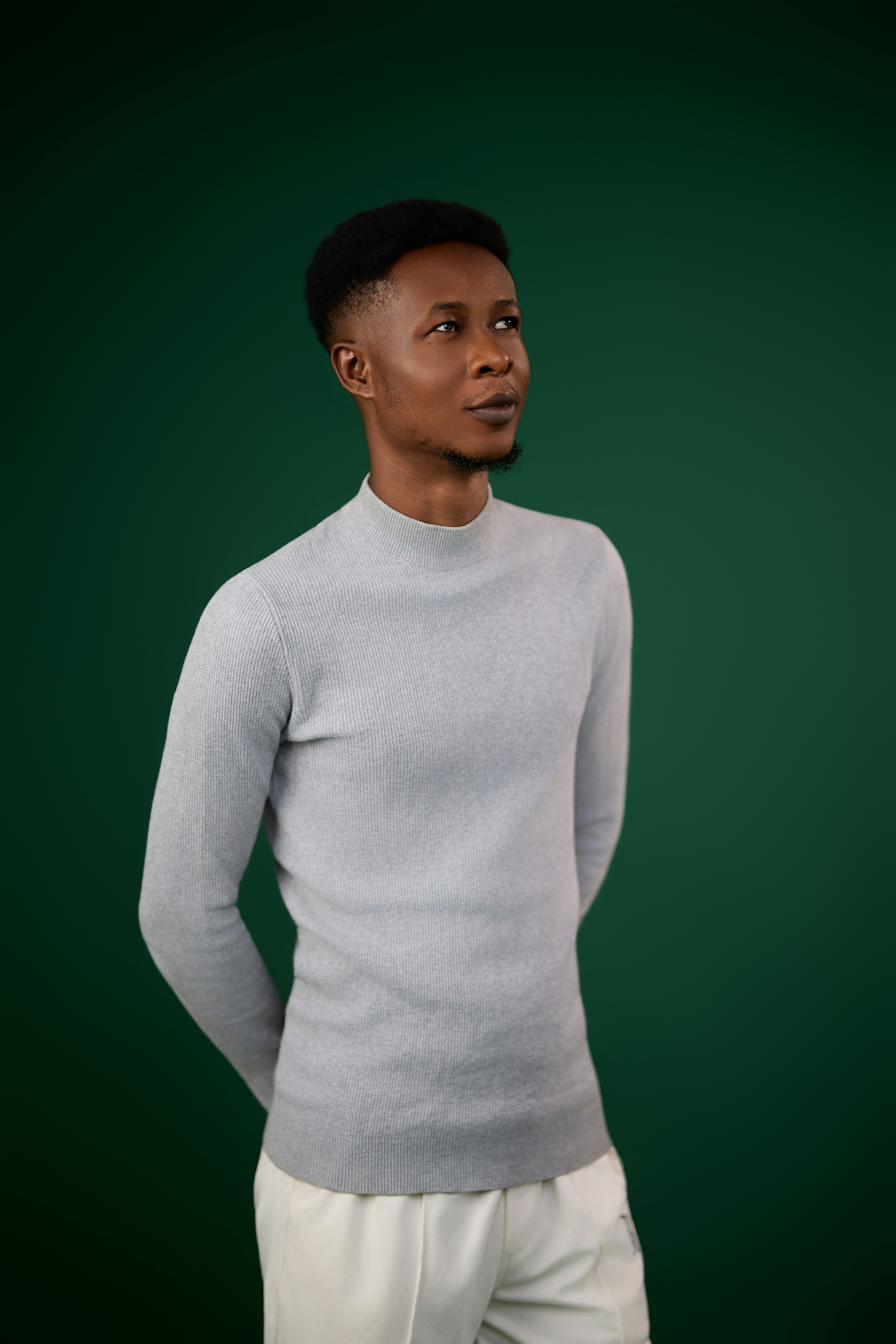Contemplative Portrait in Emerald Backdrop