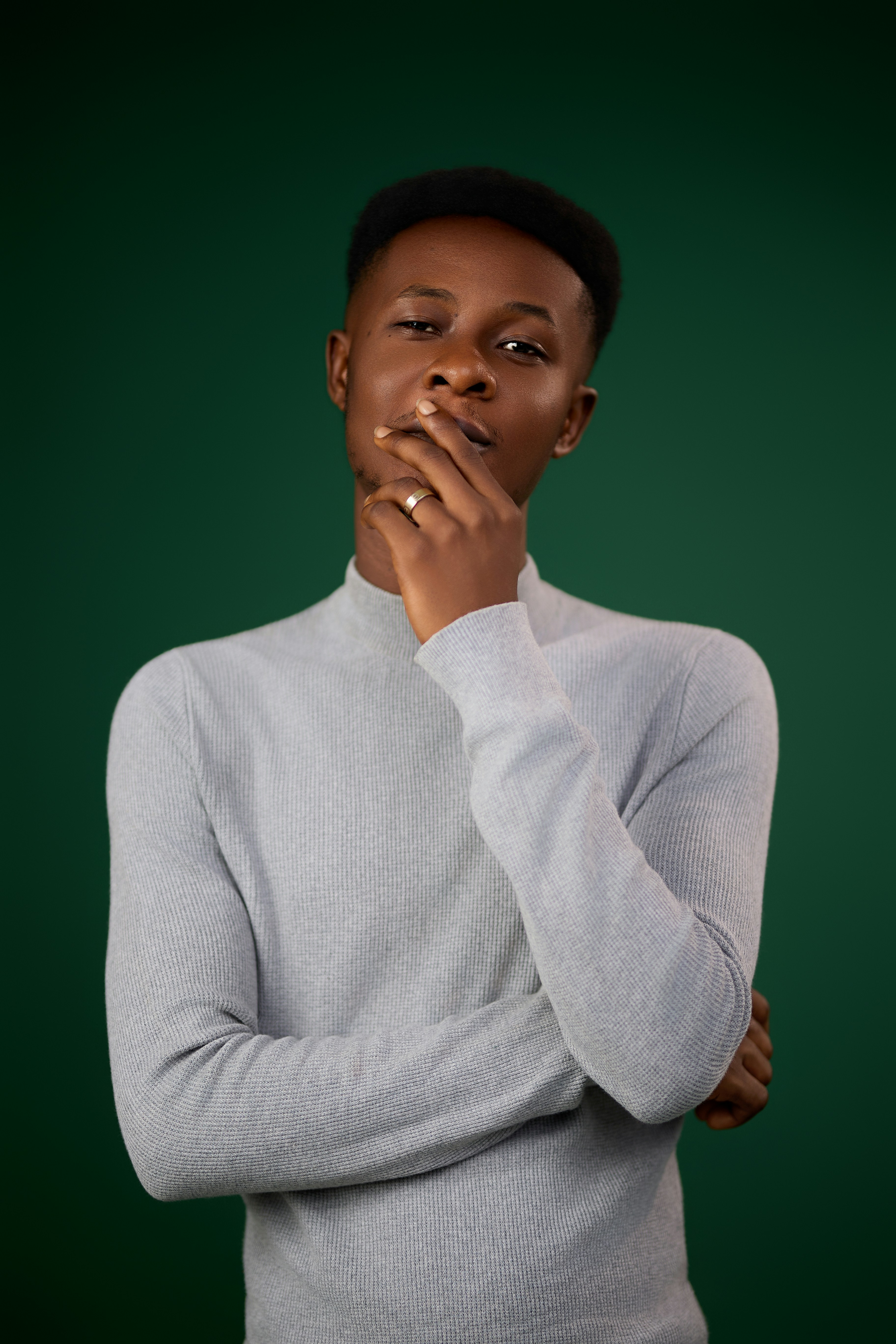 Quiet Confidence: A Portrait in Slate Knit Against Emerald