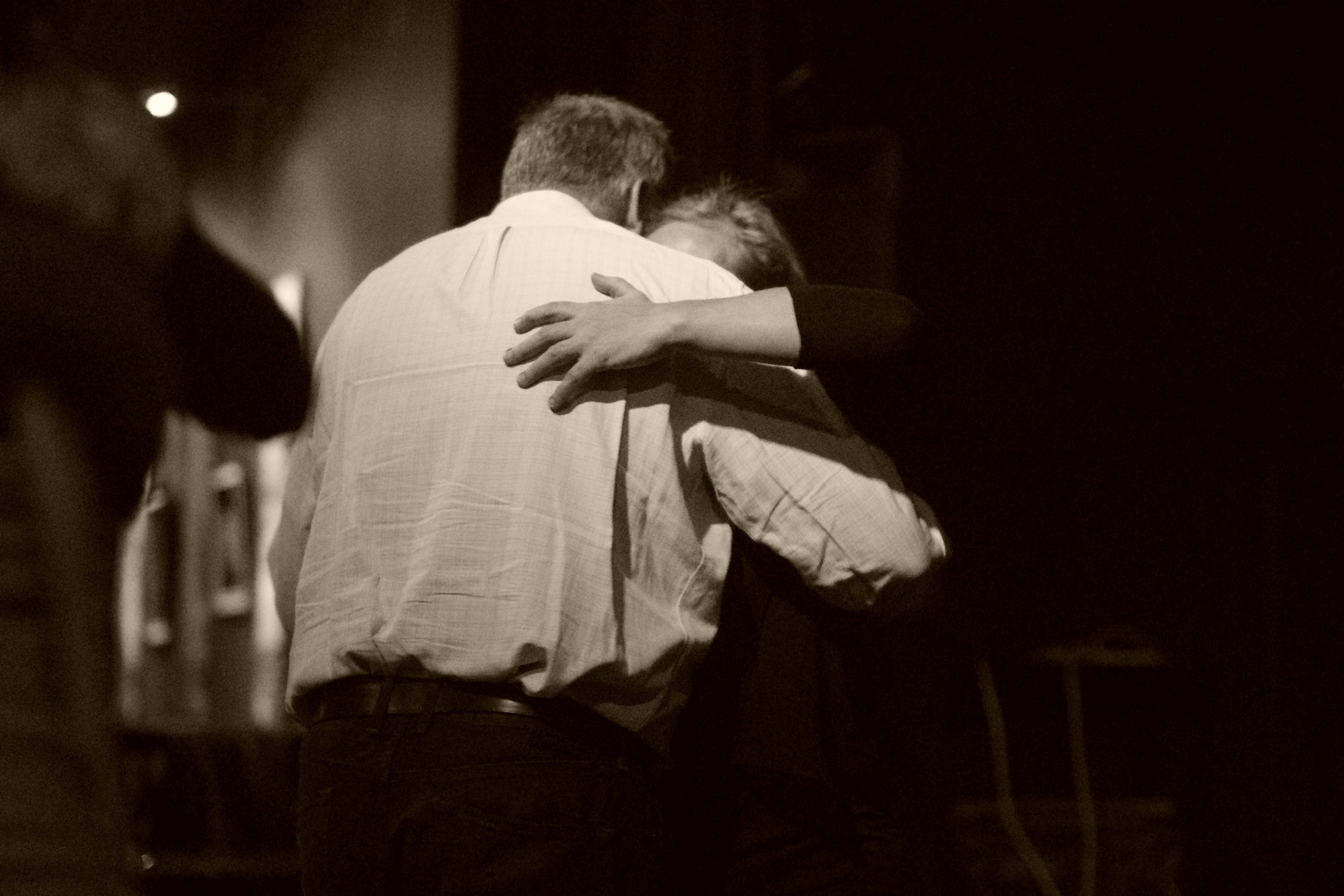 Shared Quiet: A Moment of Embrace in Low Light