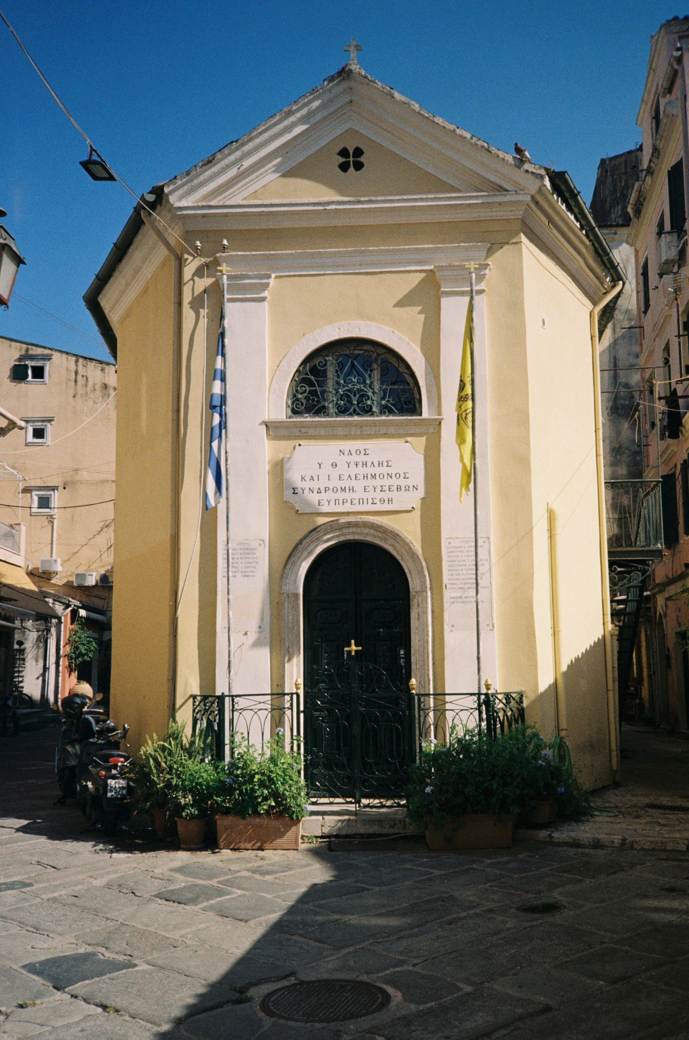 Sunlit Chapel on a Narrow Greek Lane