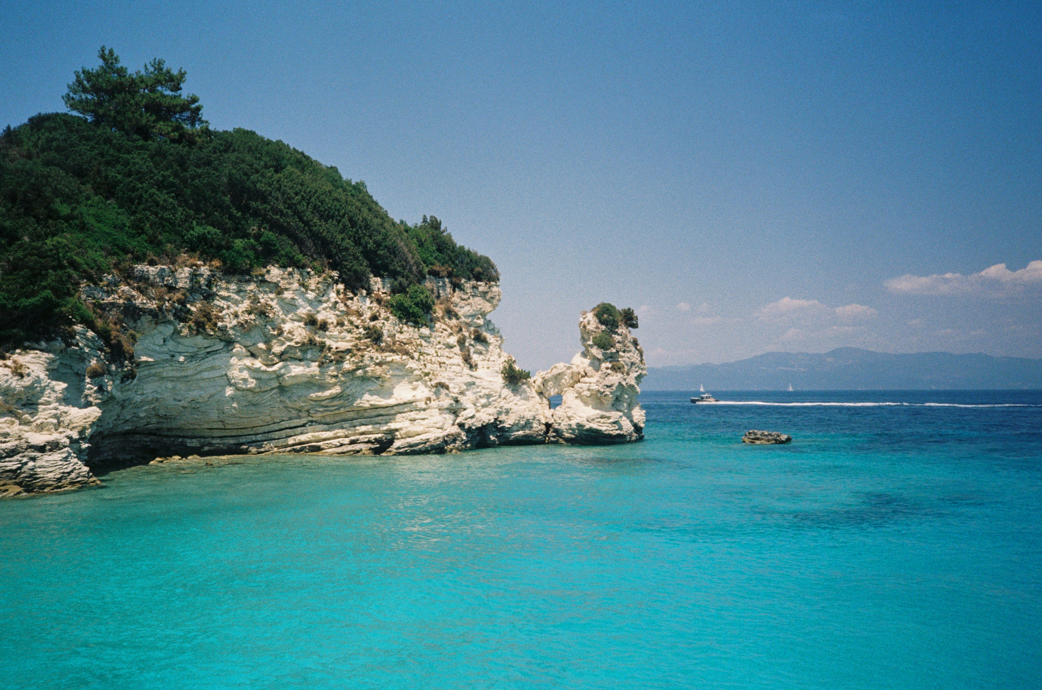 Turquoise Cove and limestone cliffs under a clear coastal sky