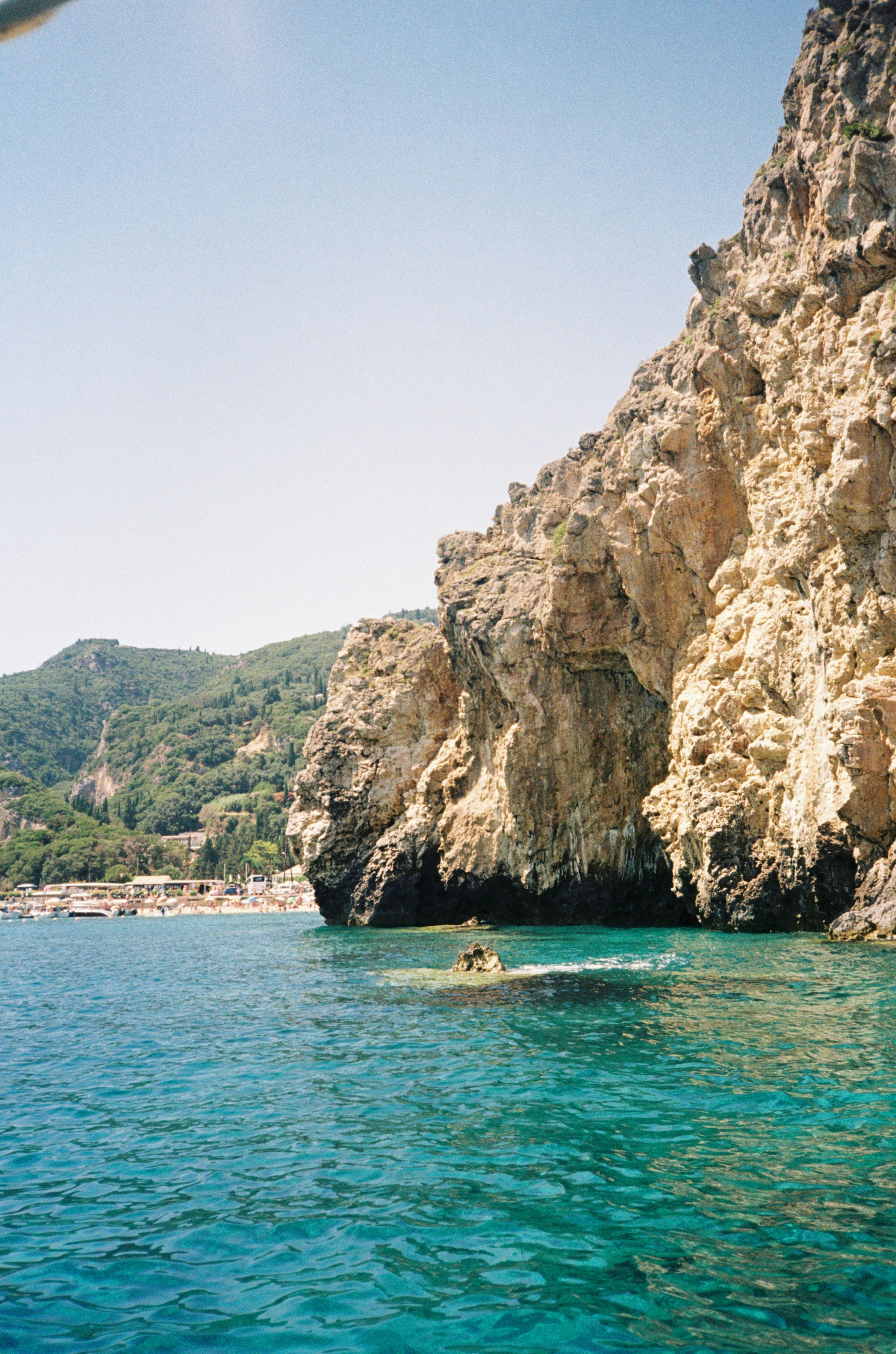 Cliffside Azure: A Quiet Sea by Sunlit Rocks
