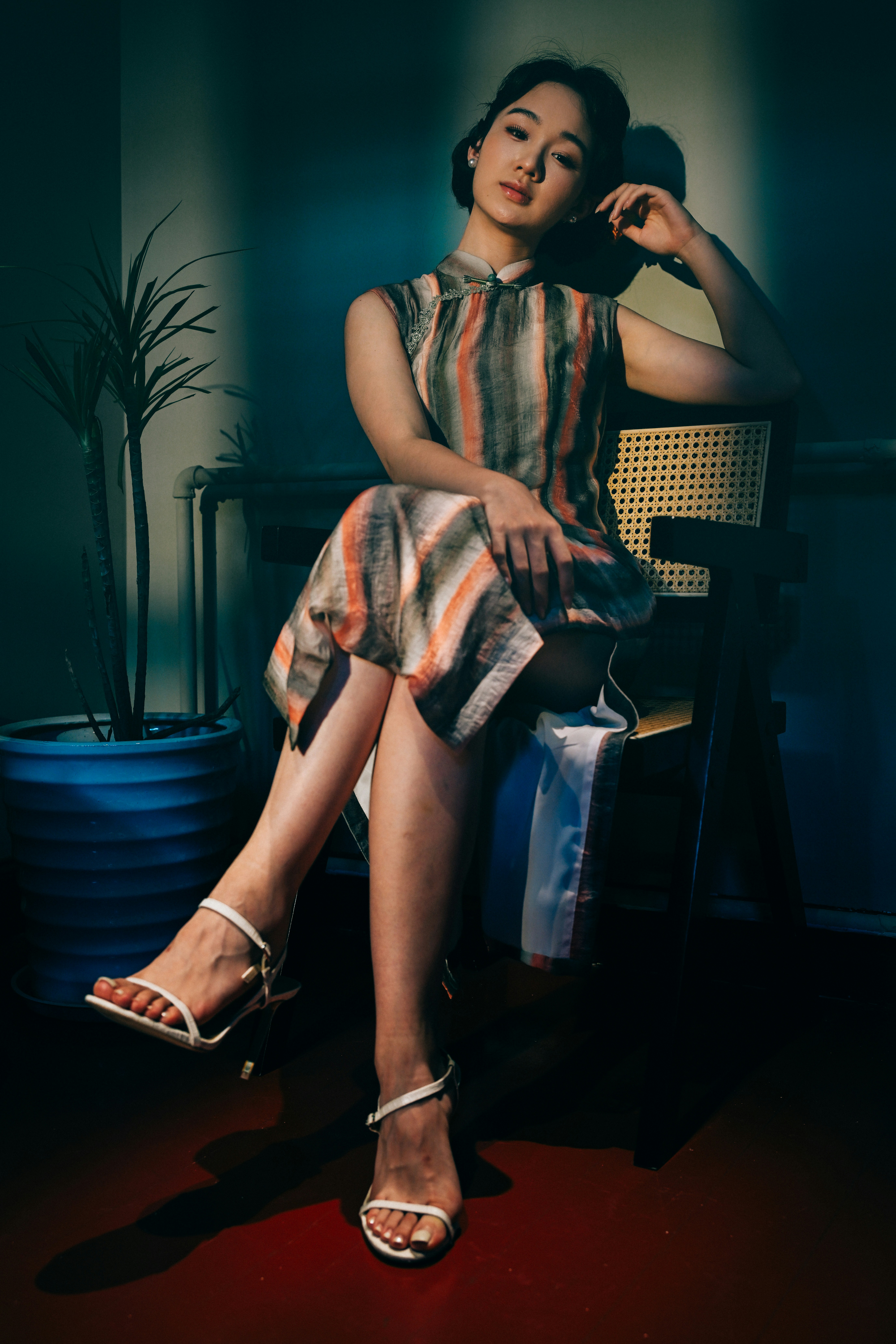 Stripes and Shadow: A Quiet Portrait Under Neon Light