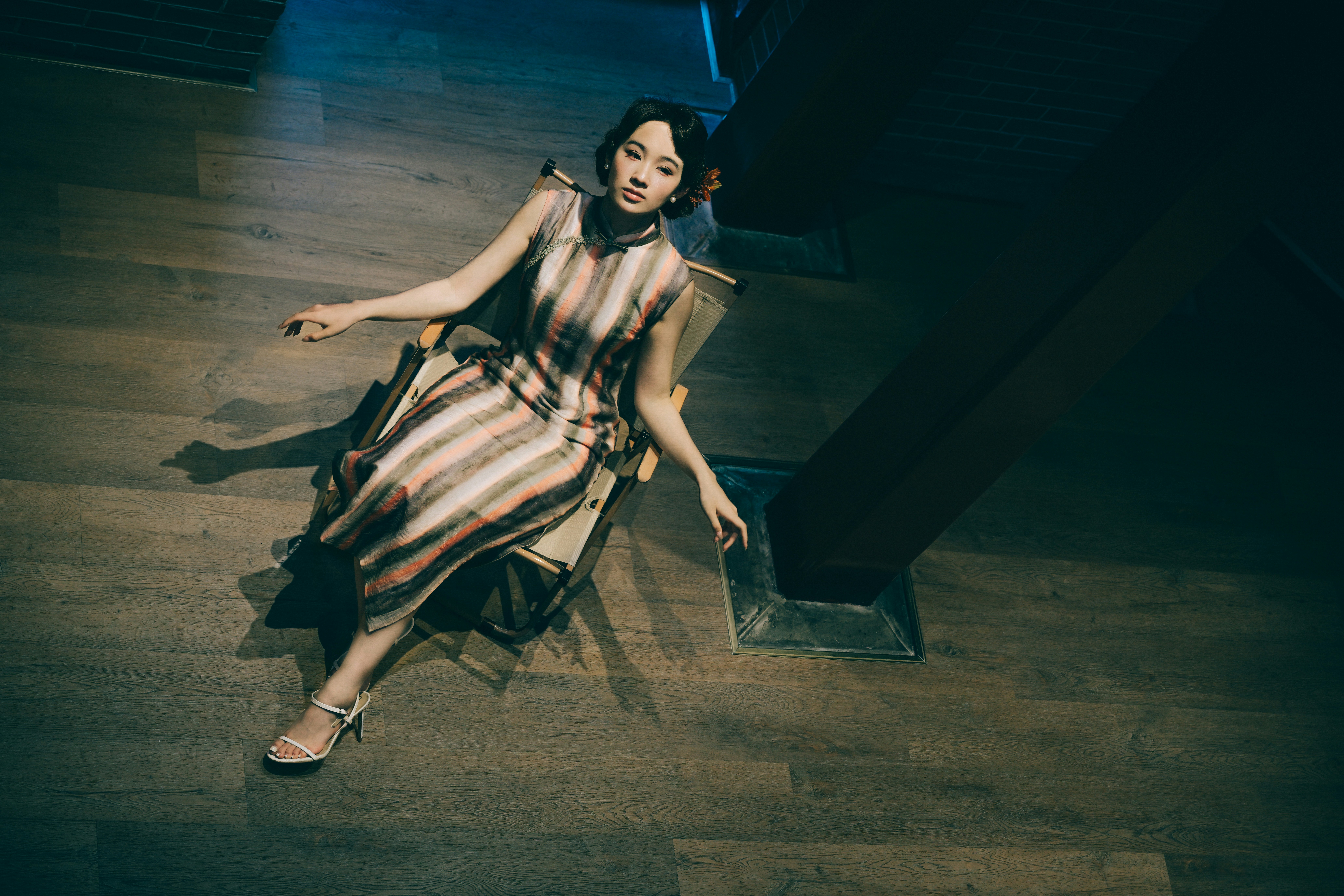 Suspended in Light: A Retro-Chic Portrait on a Wooden Stage