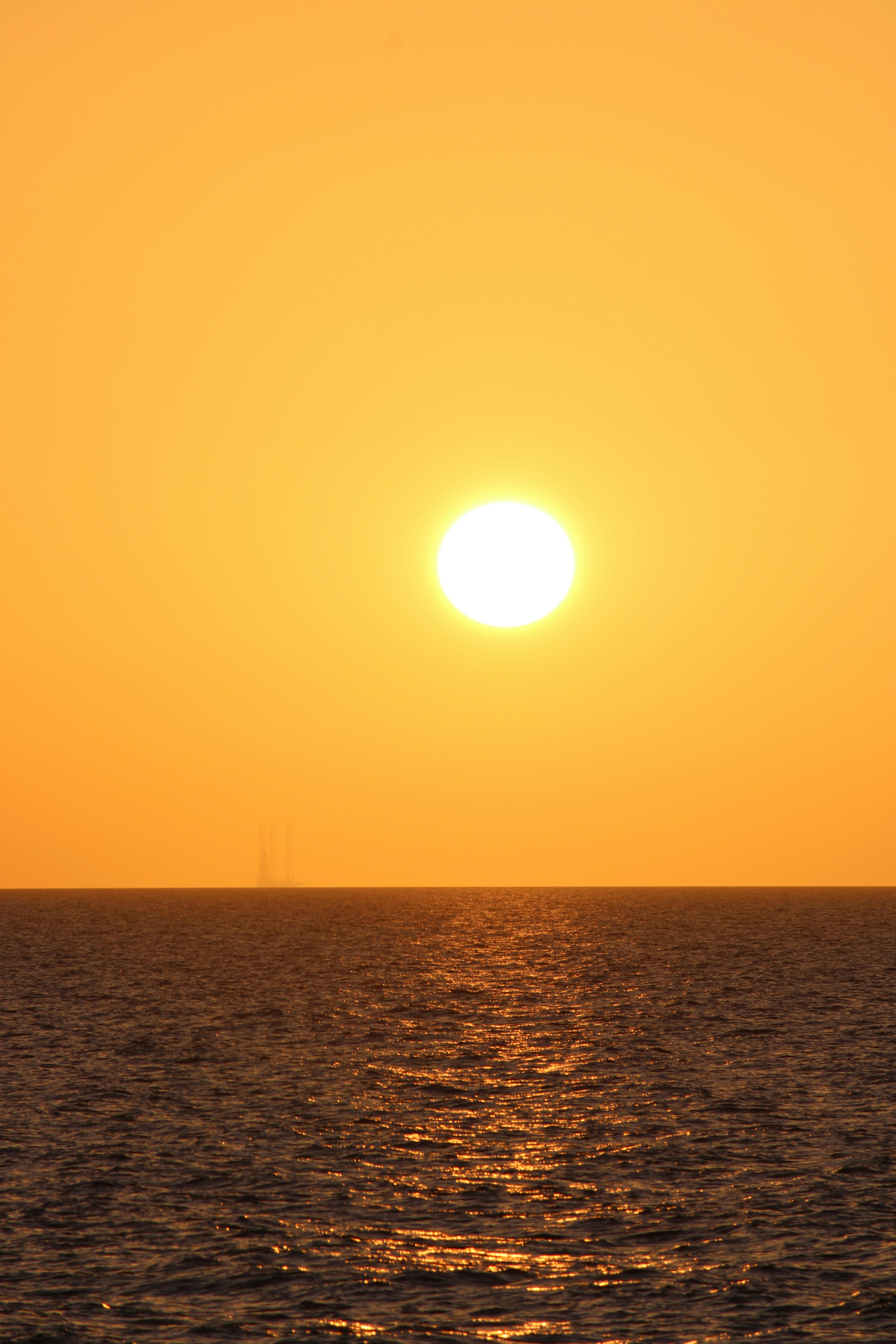 High Sun Over Calm Seas at Dusk