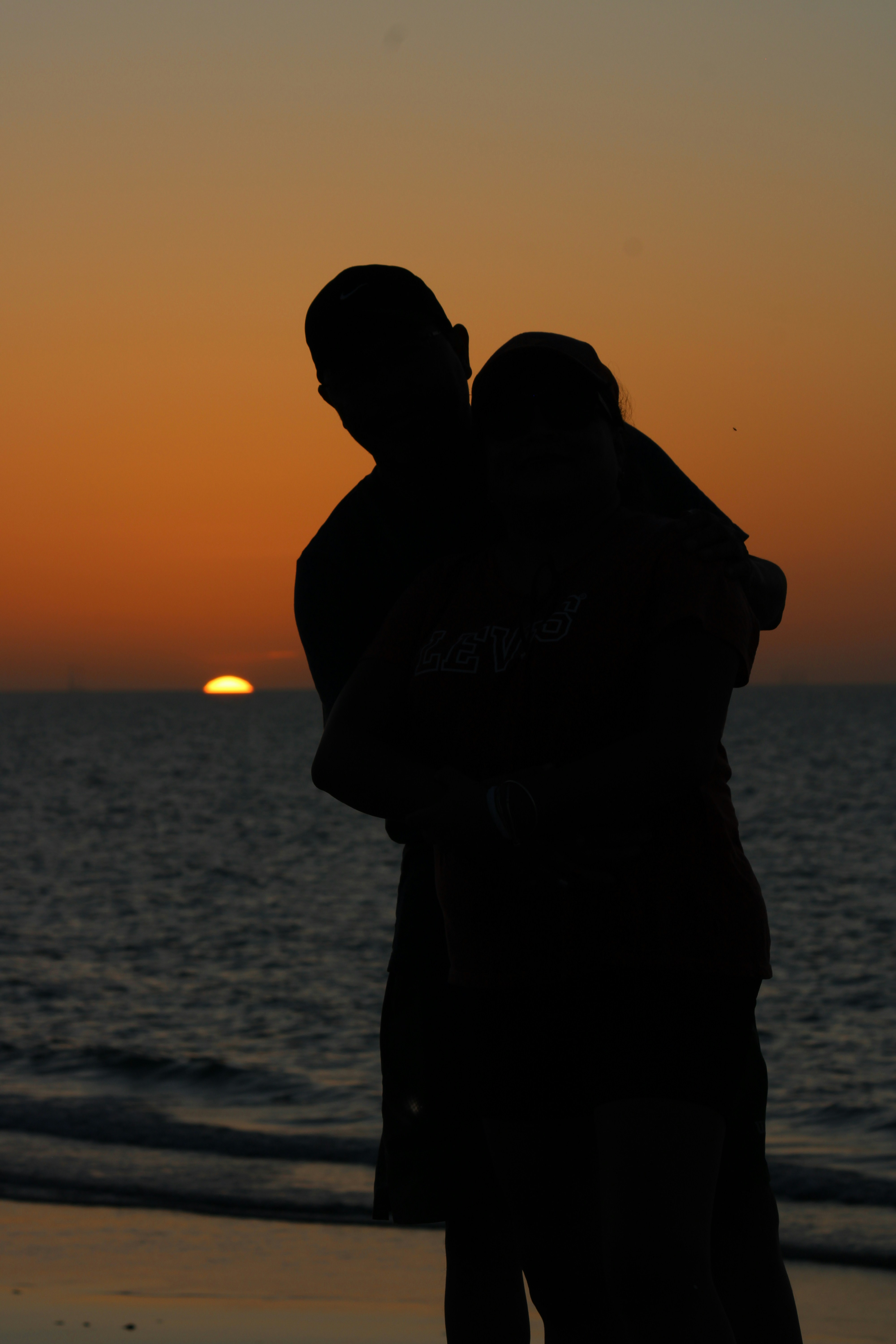 Sunset Silhouette: Embraced by the Horizon