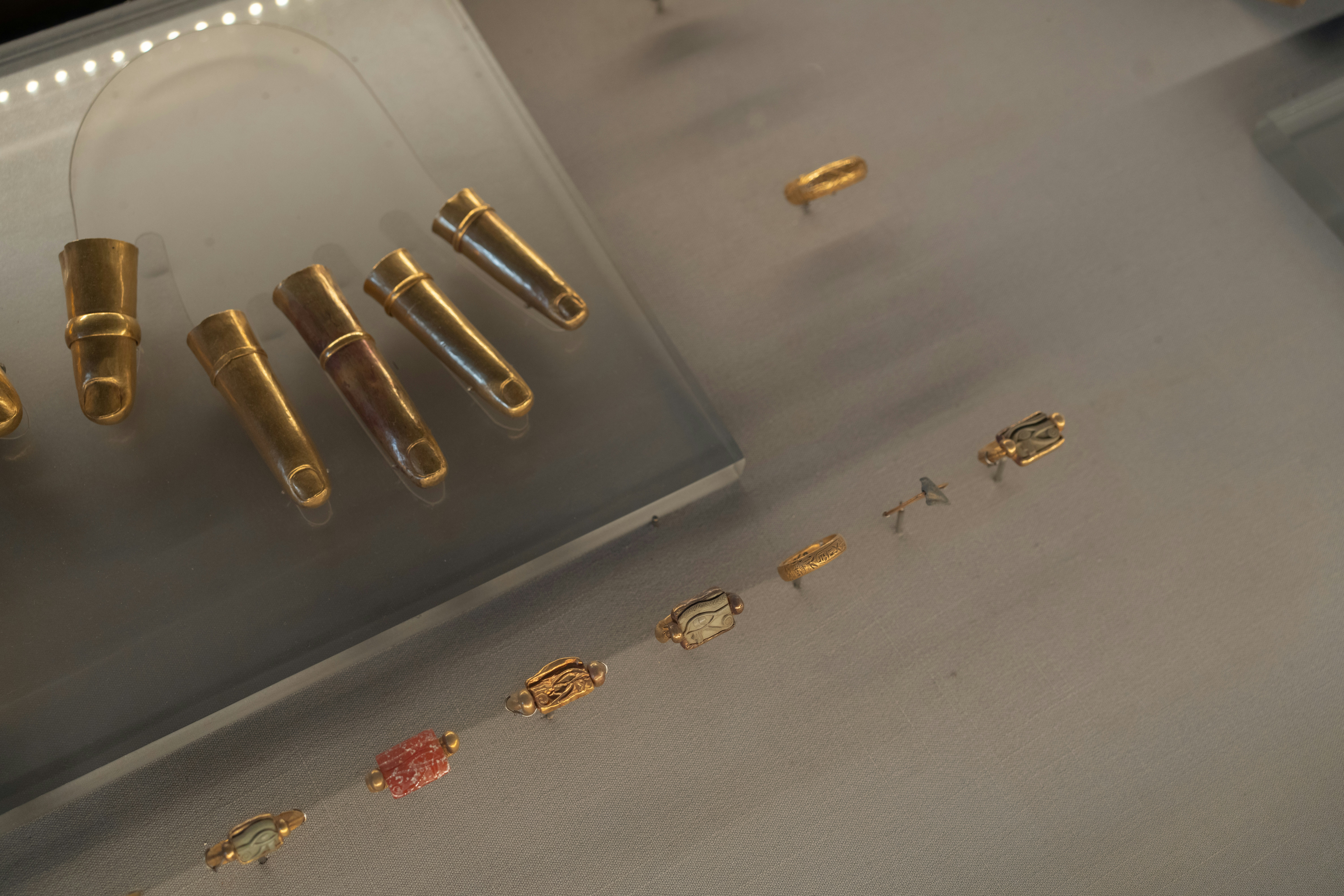 Tiny gold components and spent casings on a pale surface