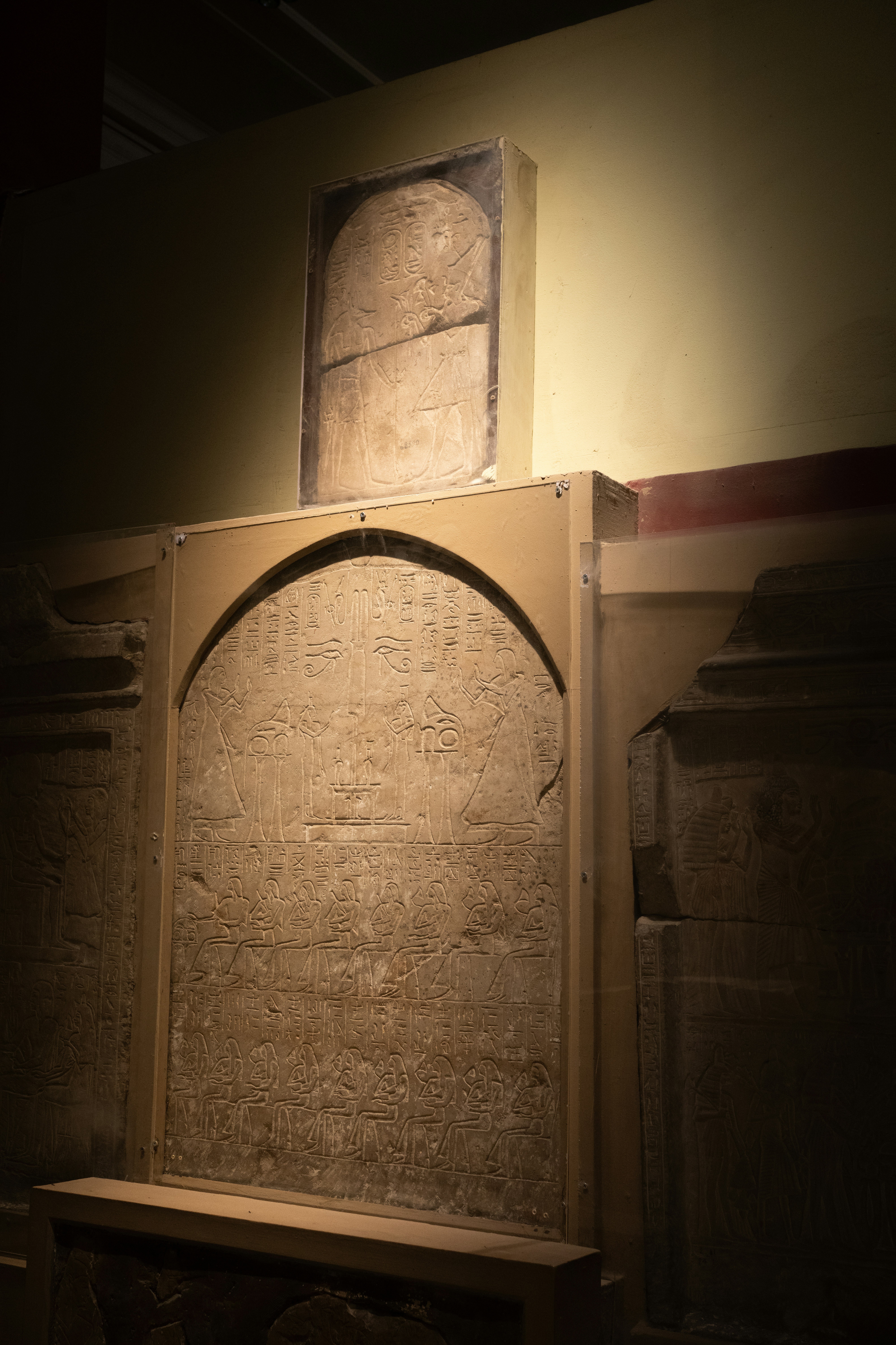 Stone Tablet Shrine: Dimly Lit Display of Ancient Carvings