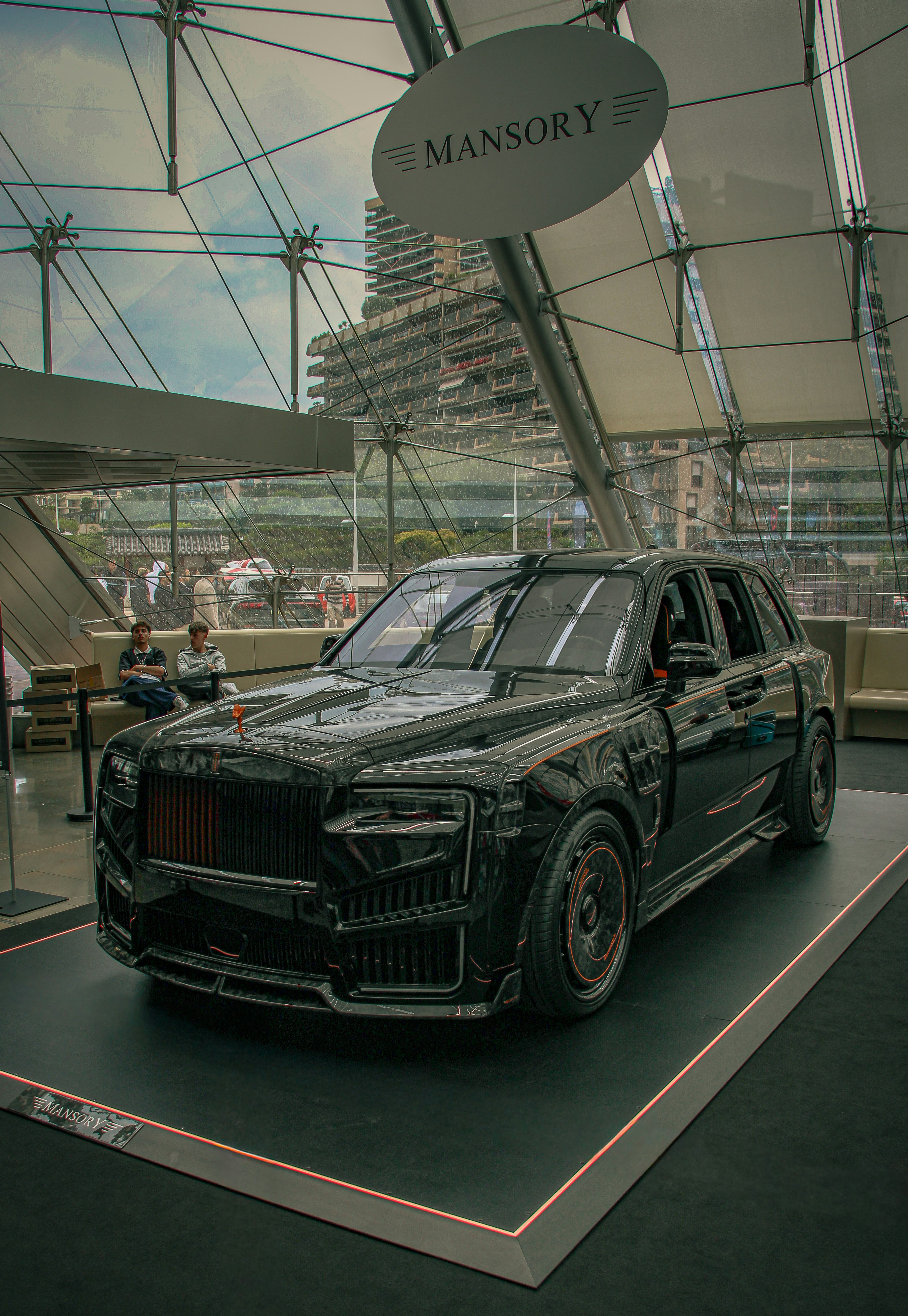 Luxurious Presence: Mansory Blackout SUV on a Lit Platform