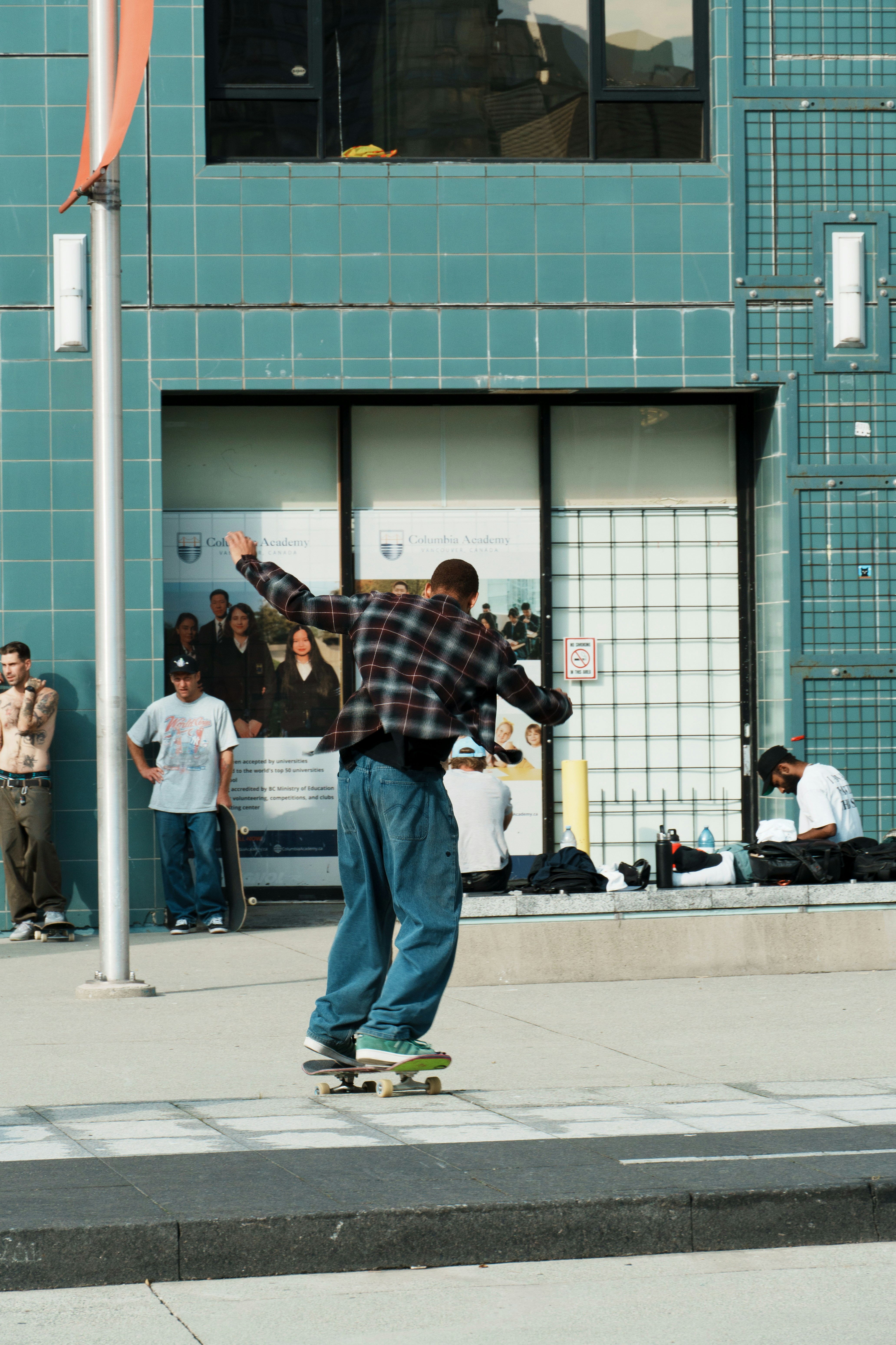 Skateboarder in mid-tilt at urban plaza