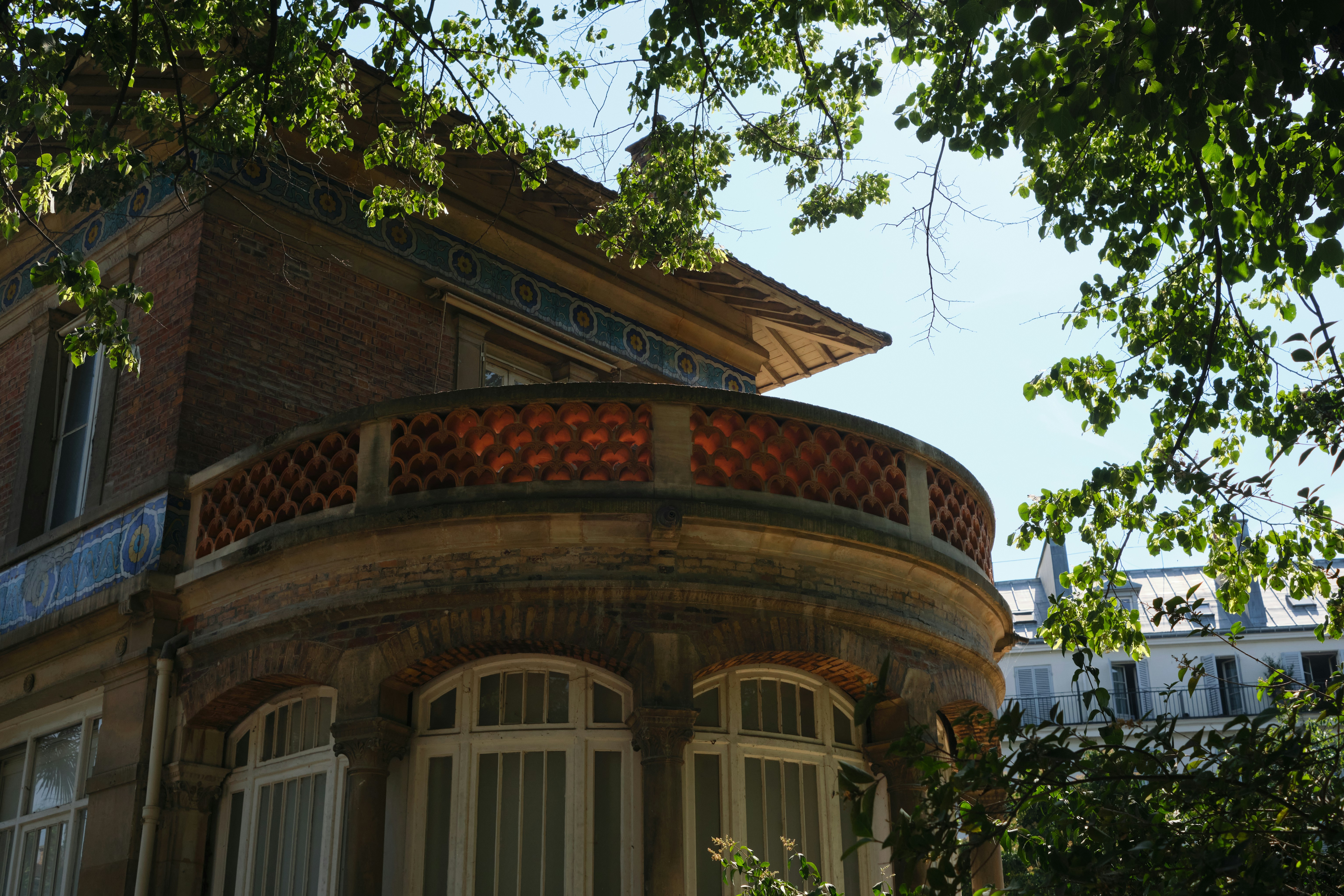 Curved Balcony Facade under a canopy of green