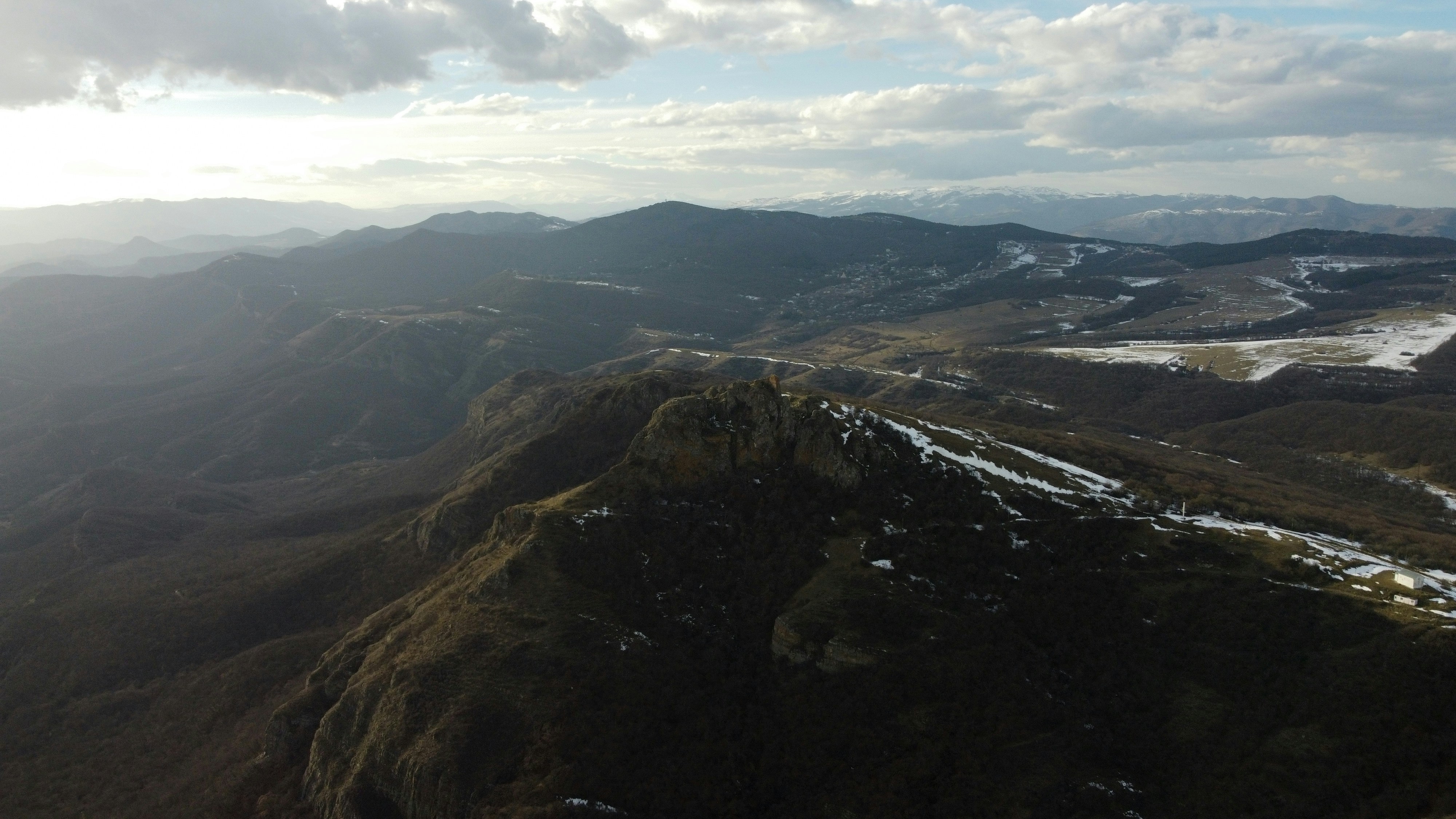 Highland Crest: A Quiet Edge Over Snow-Kissed Valleys