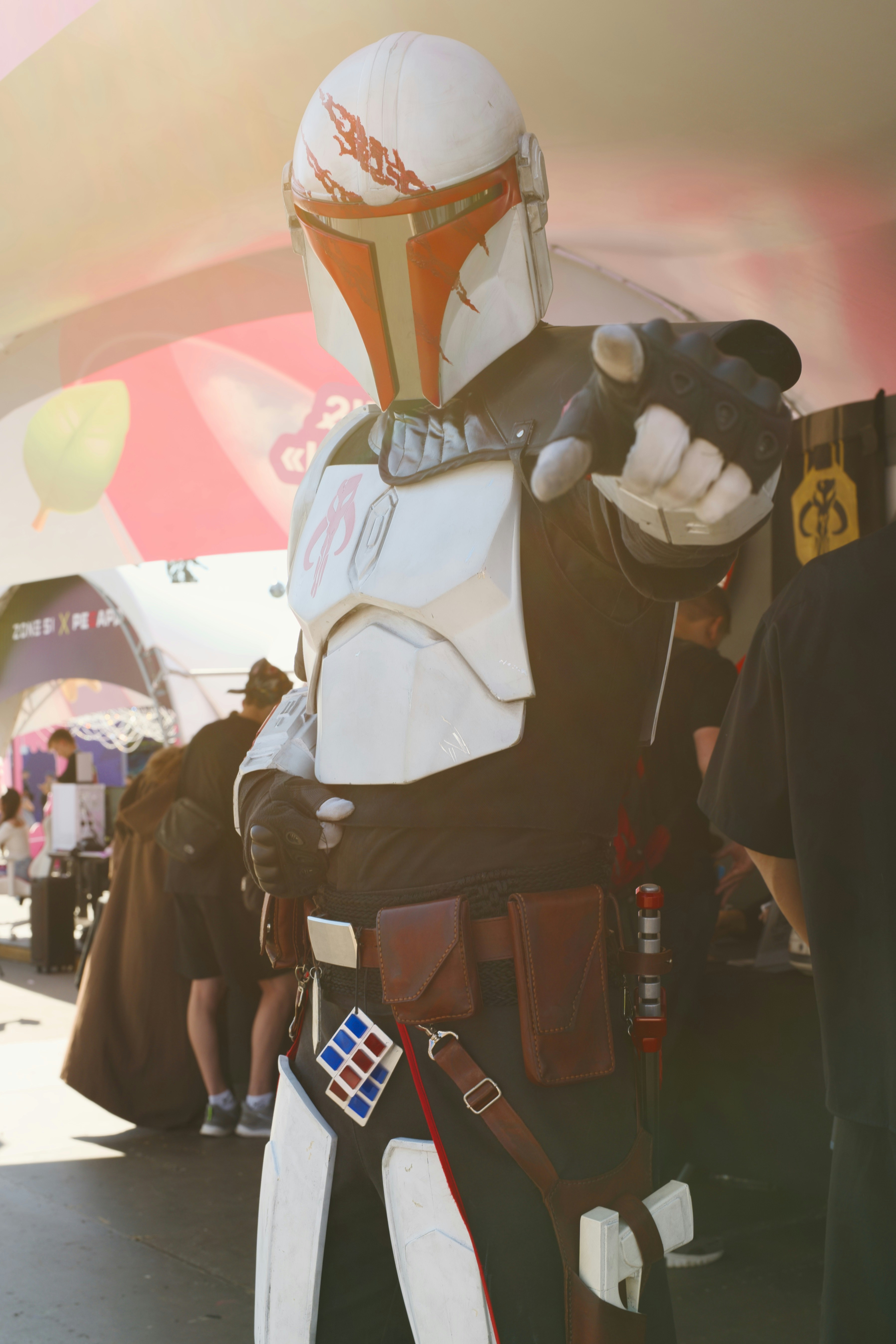 Mercenary in White Armor Extends a Gesture at a Busy Convention Floor
