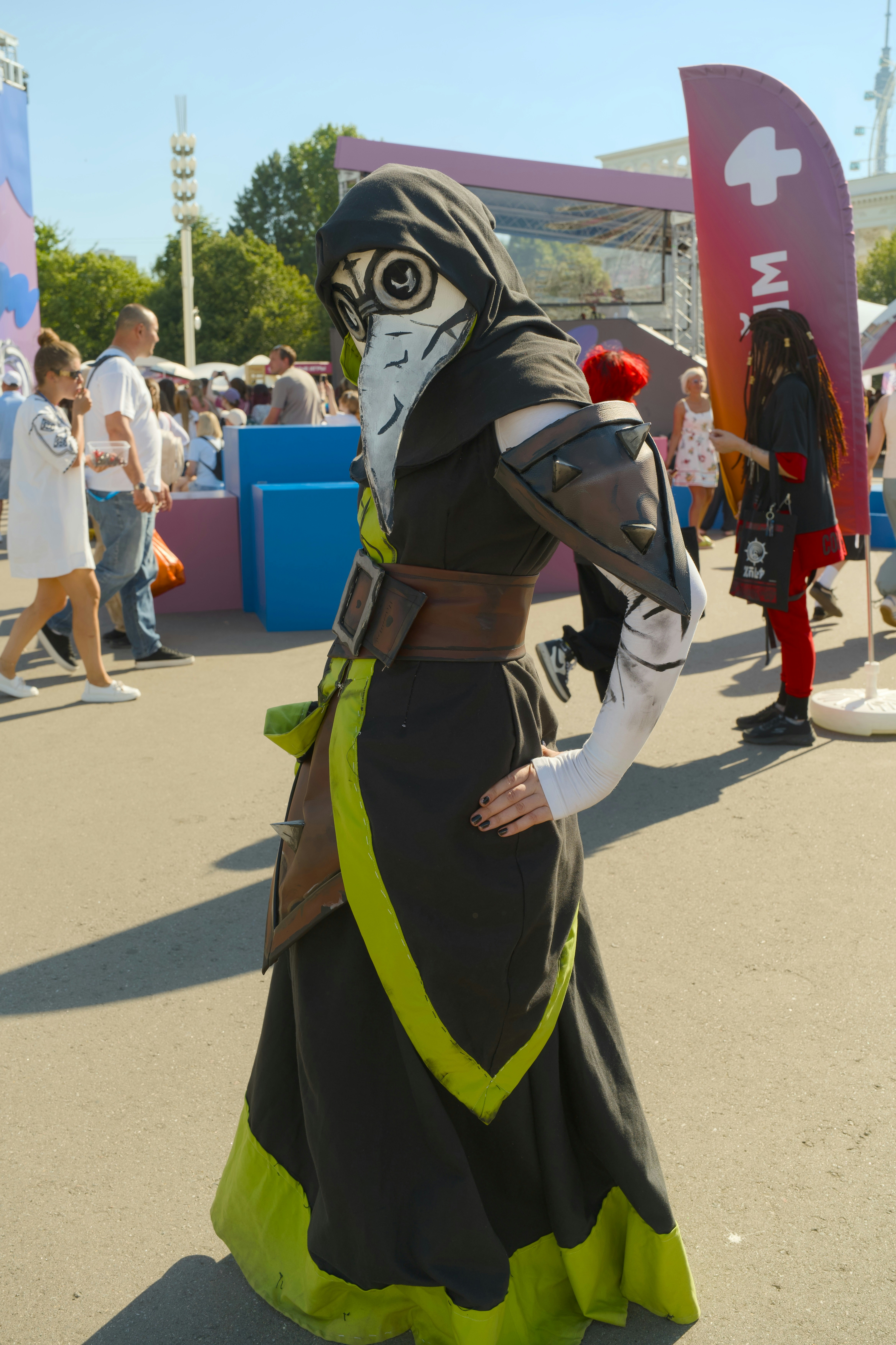 Masked Wanderer in Neon-Trimmed Garb at a Sunlit Festival