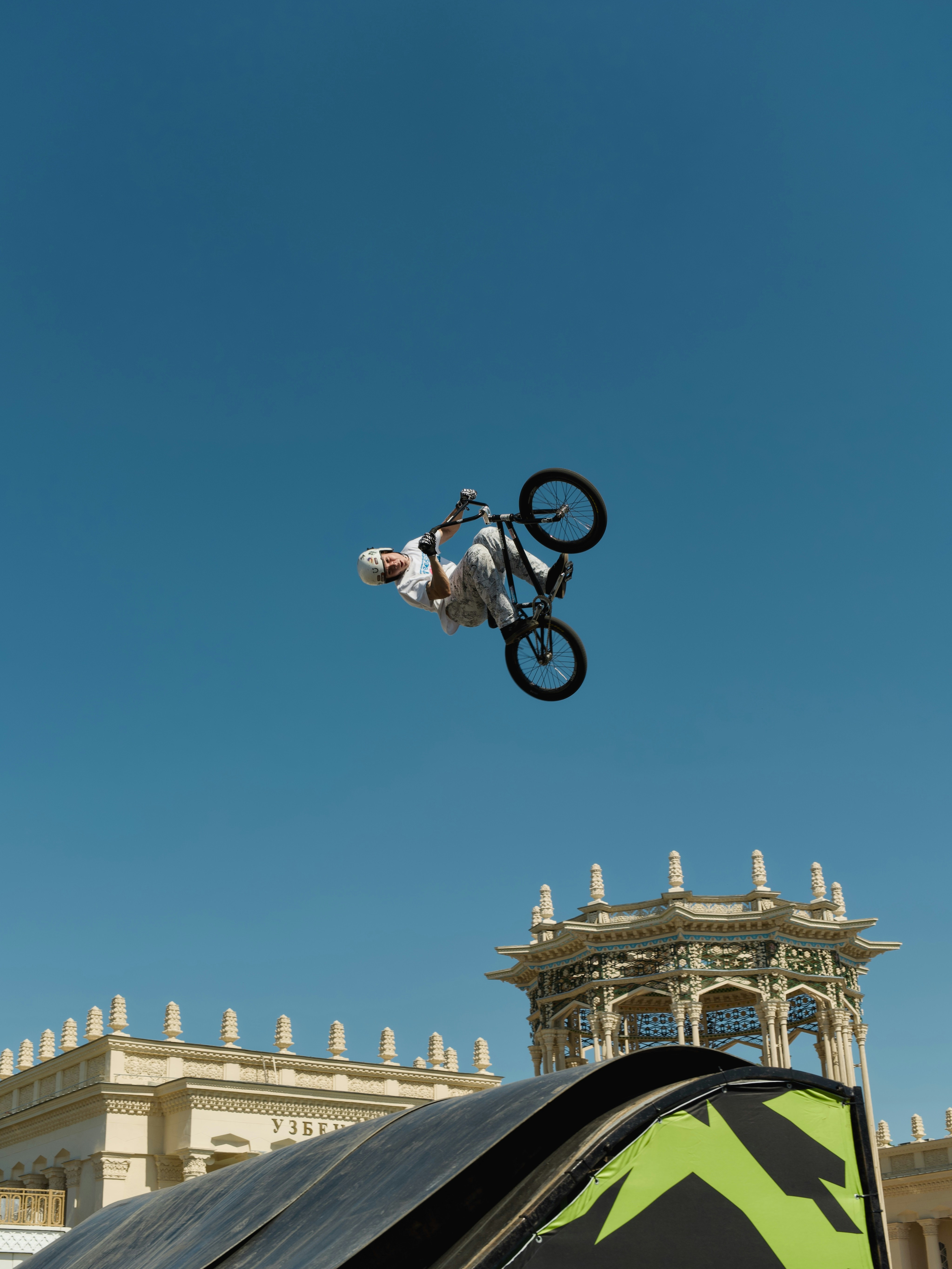 Midair Maverick: A BMX Rider Flies Over Architectural Carvings
