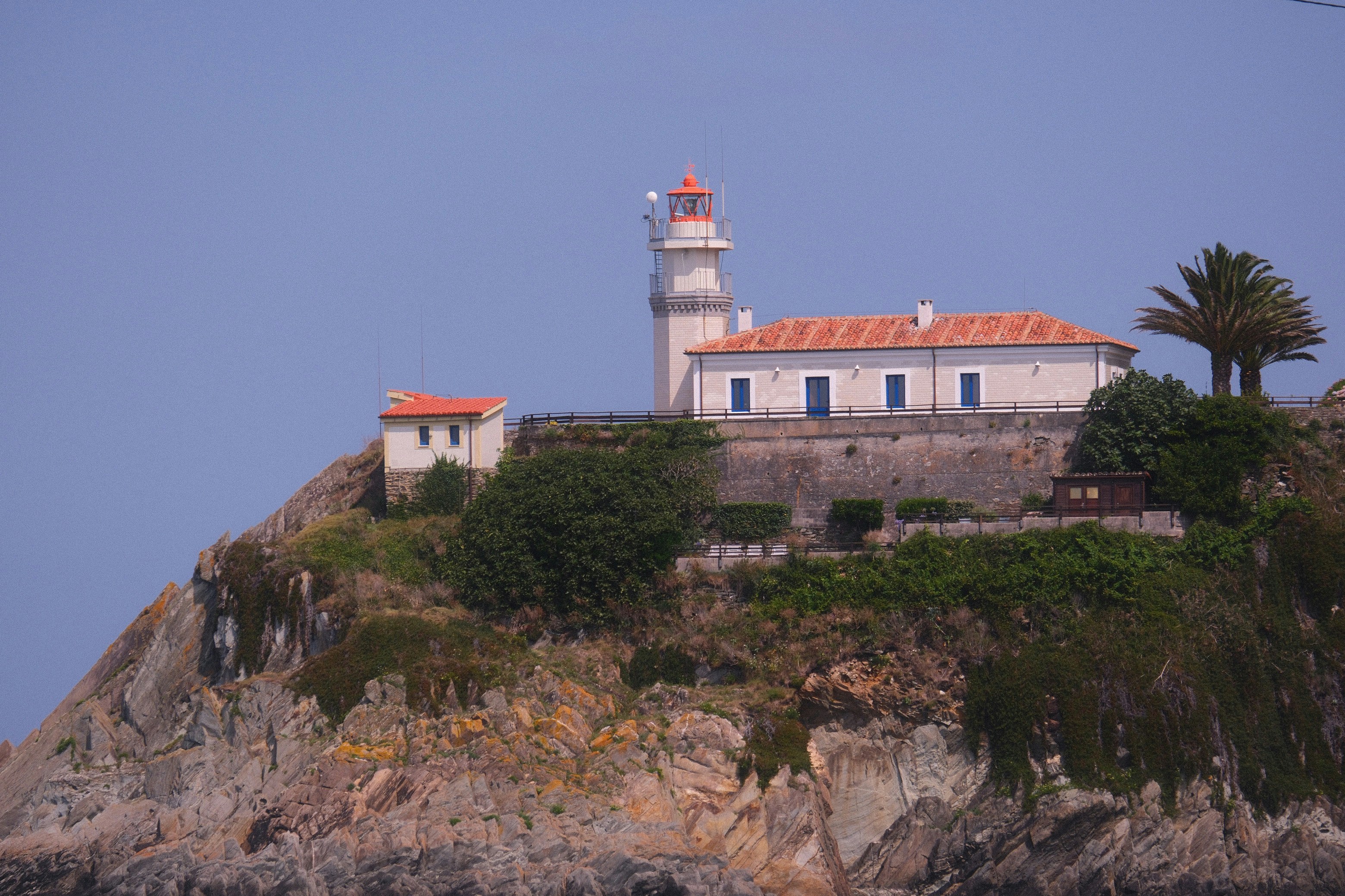 Lighthouse Sentinel Over the Cliff: A Coastal Keep Stand