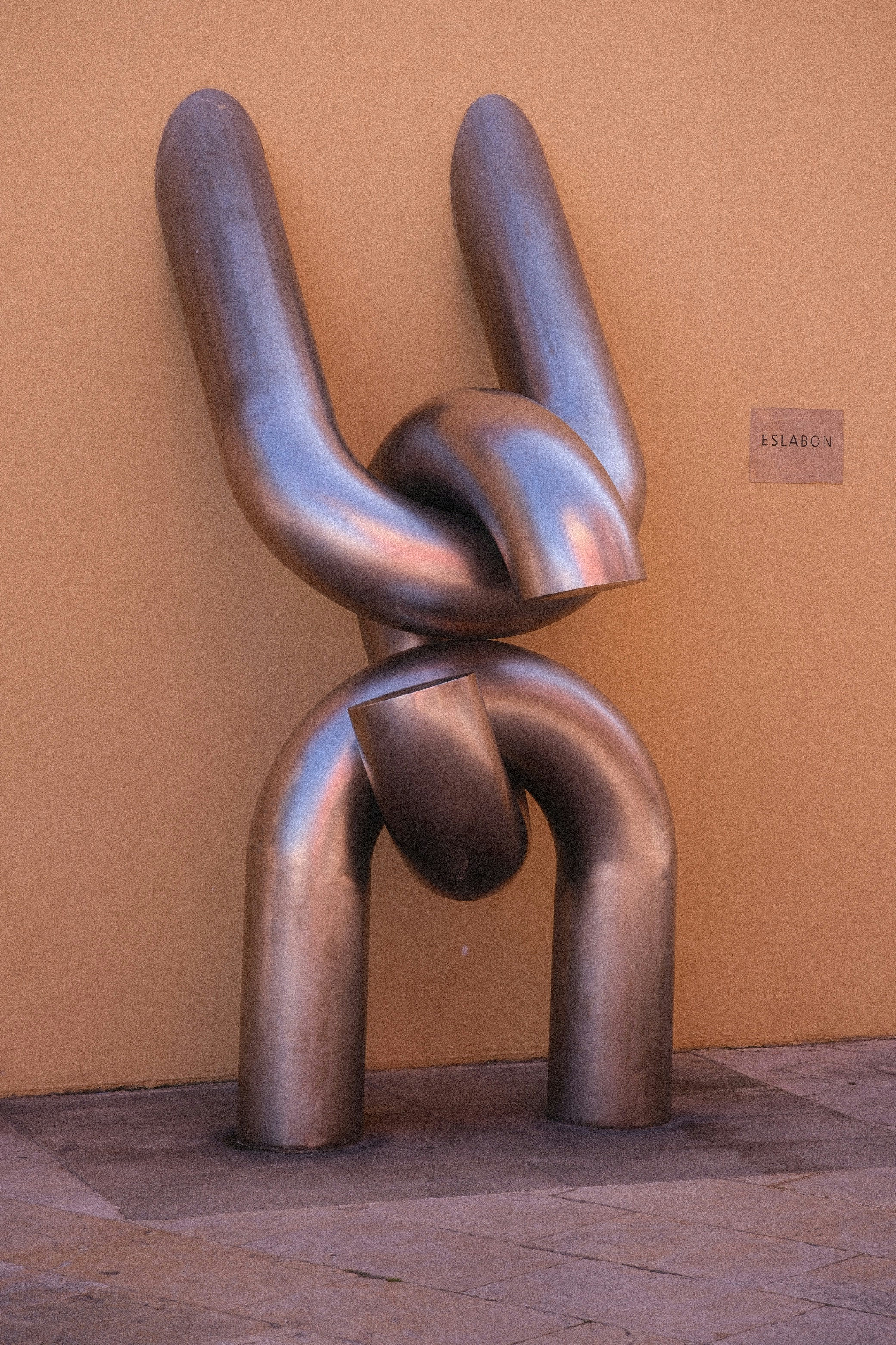 Interwoven Rails: A Sculptural Twist in Coppery Light
