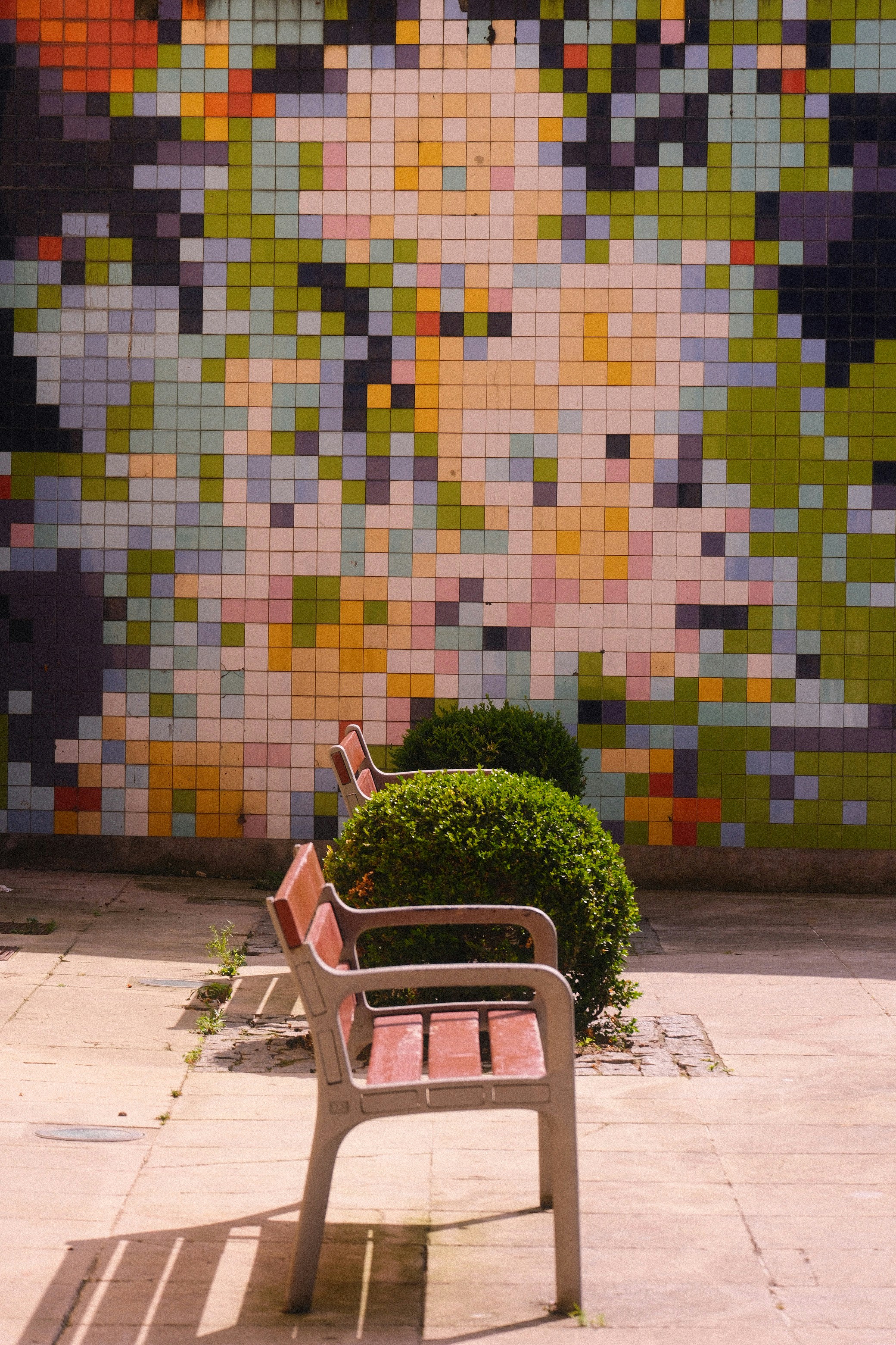 Color Mosaic Mornings: Benches Align Under a Pixelated Wall