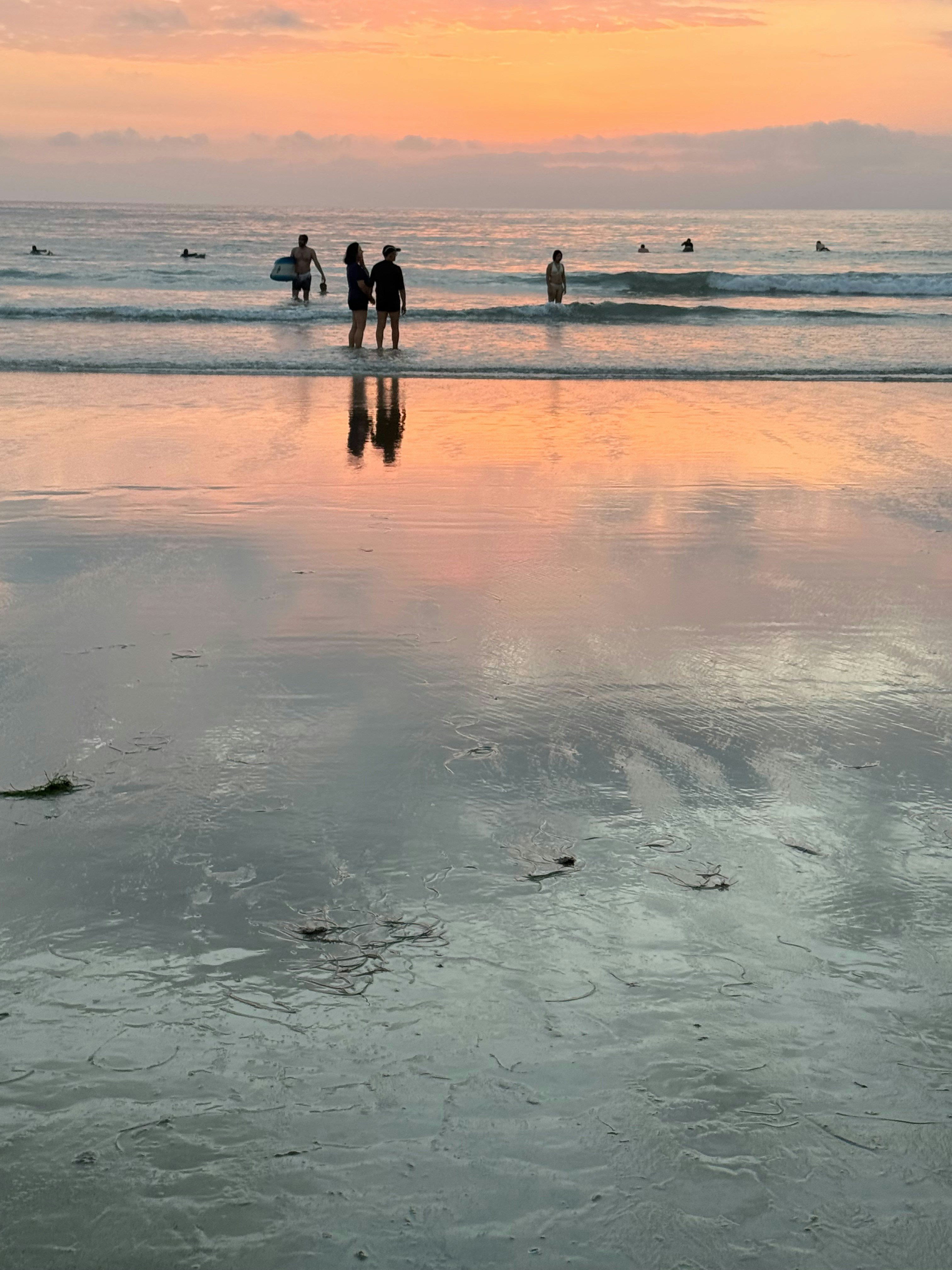 Couple and Surfers at Sunset Gentle Tide