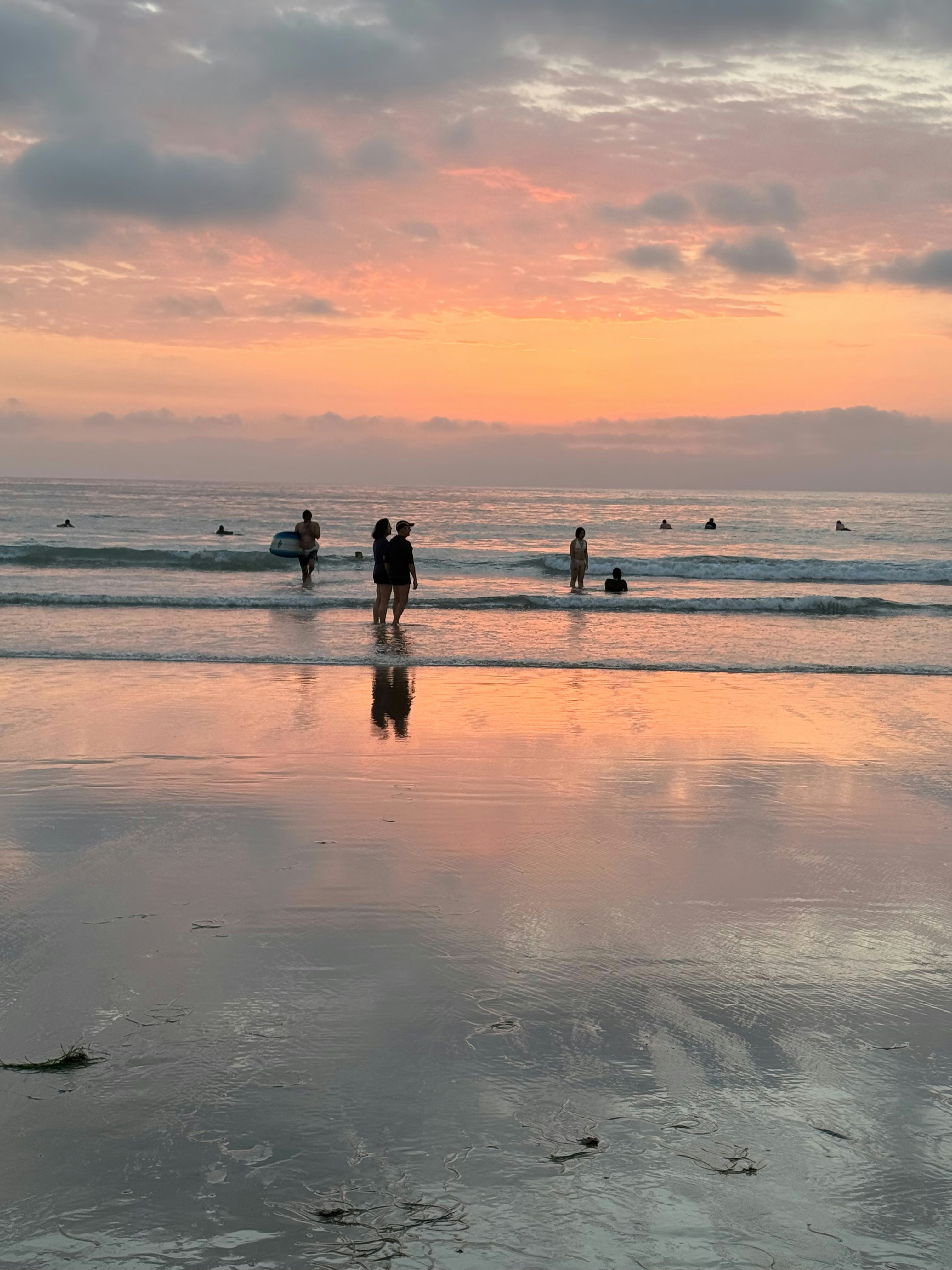Sunset Silhouette by the Tide: Couples at the Waterline