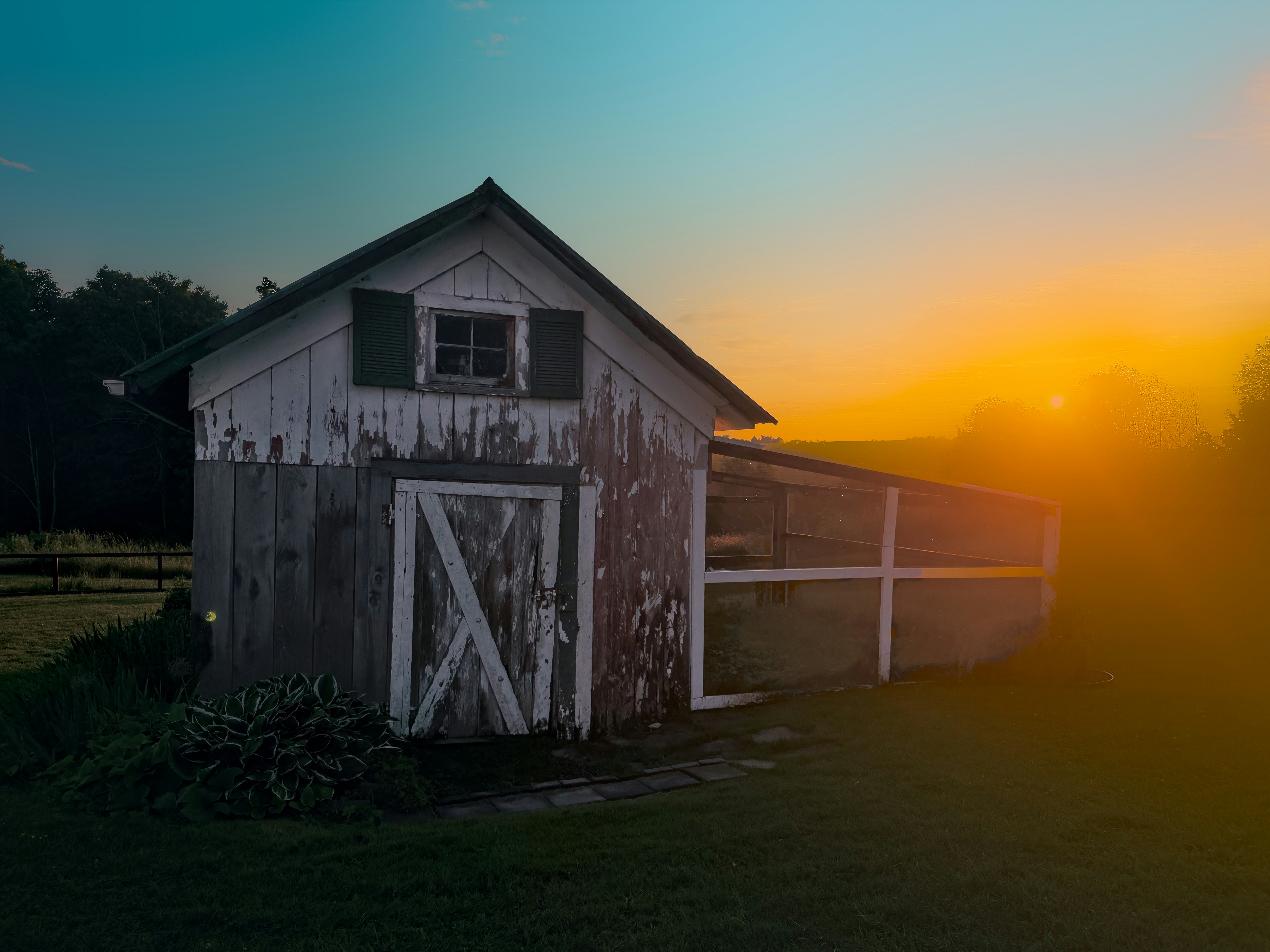 Sunlit Shack at Dusk: Weathered Farmstead Bathed in Golden Halo