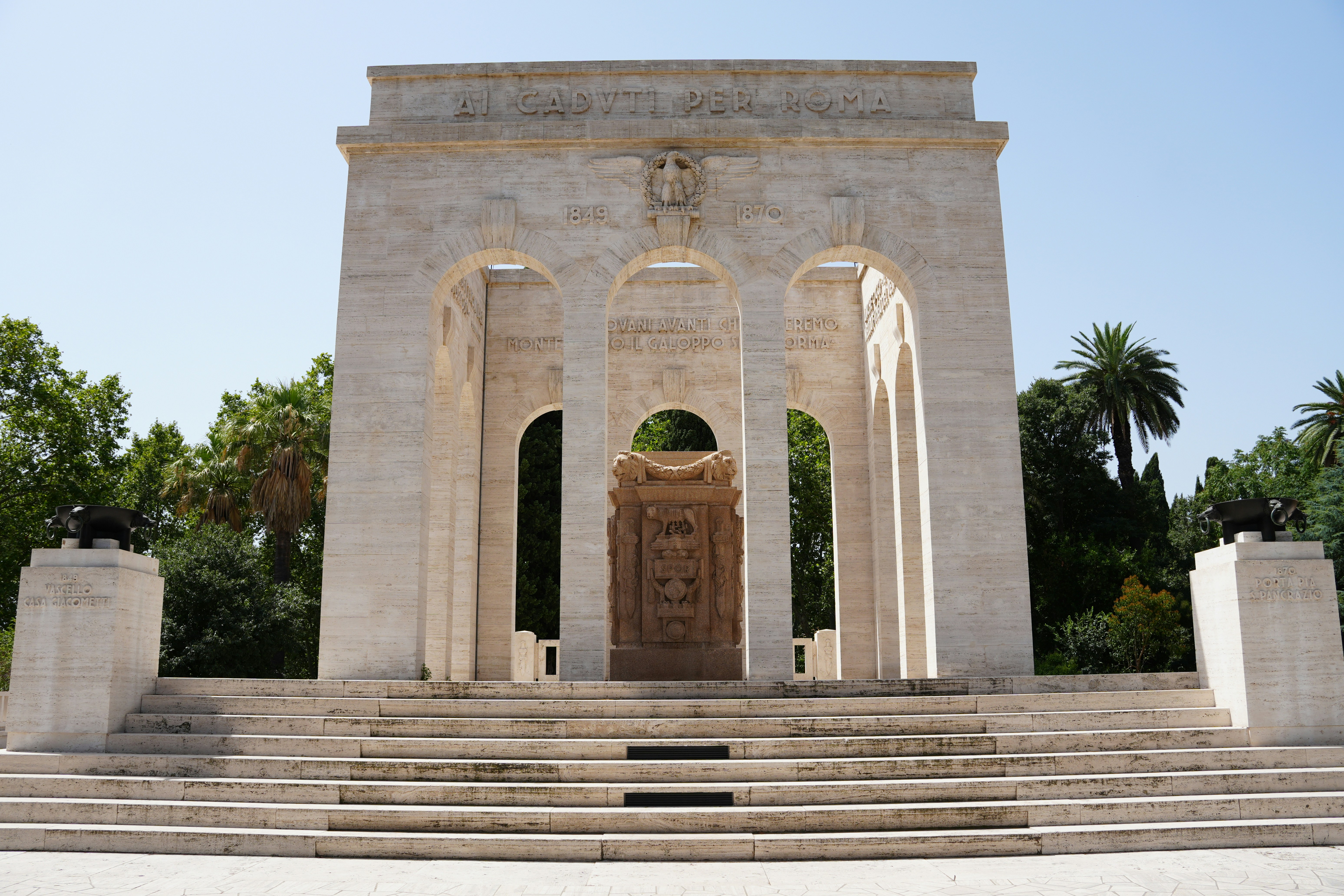 Arcade of Reverence: Stone Archway and Central Crest Monument