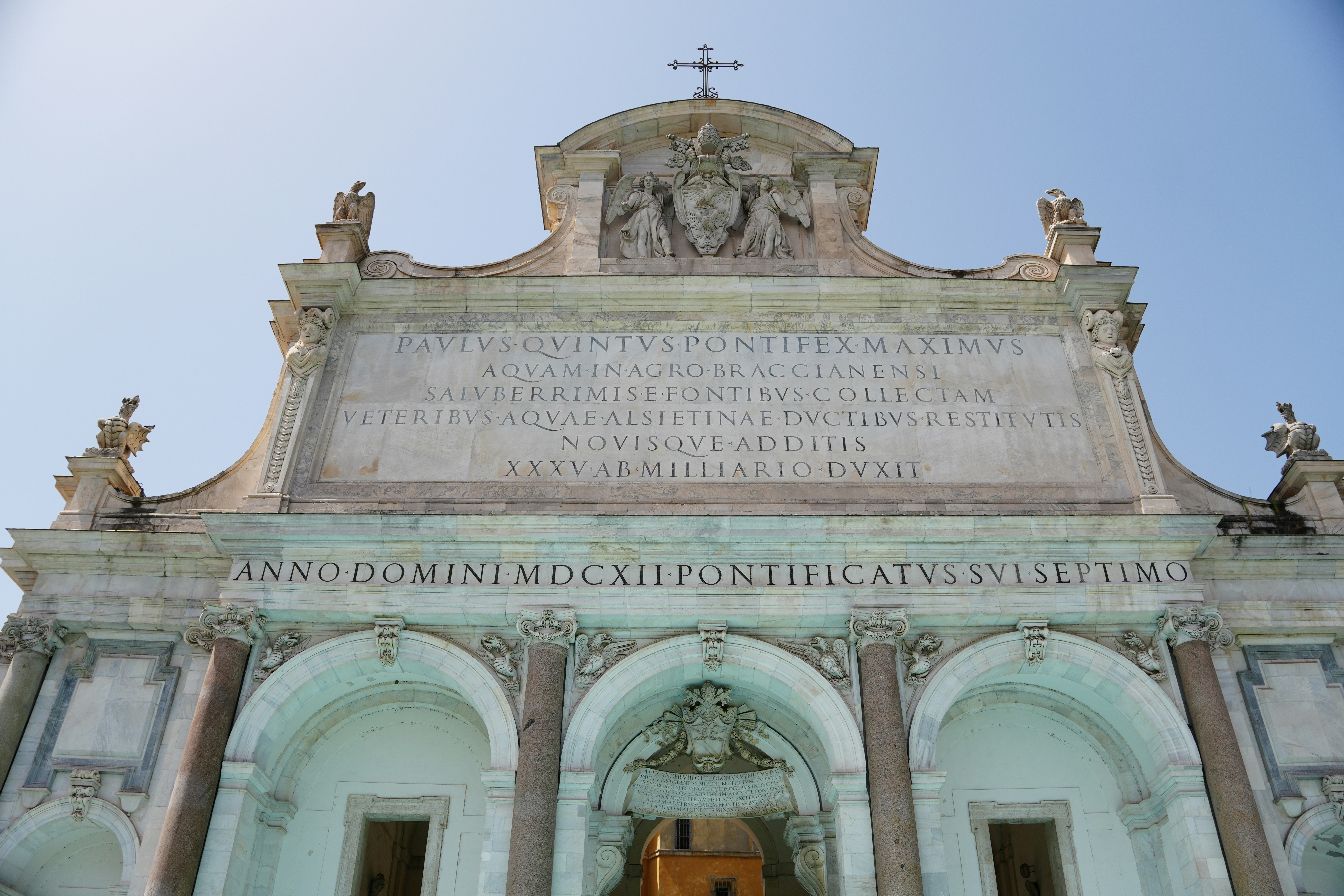 Stonecrest Facade: Carved Chronicle Above the Arched Entry