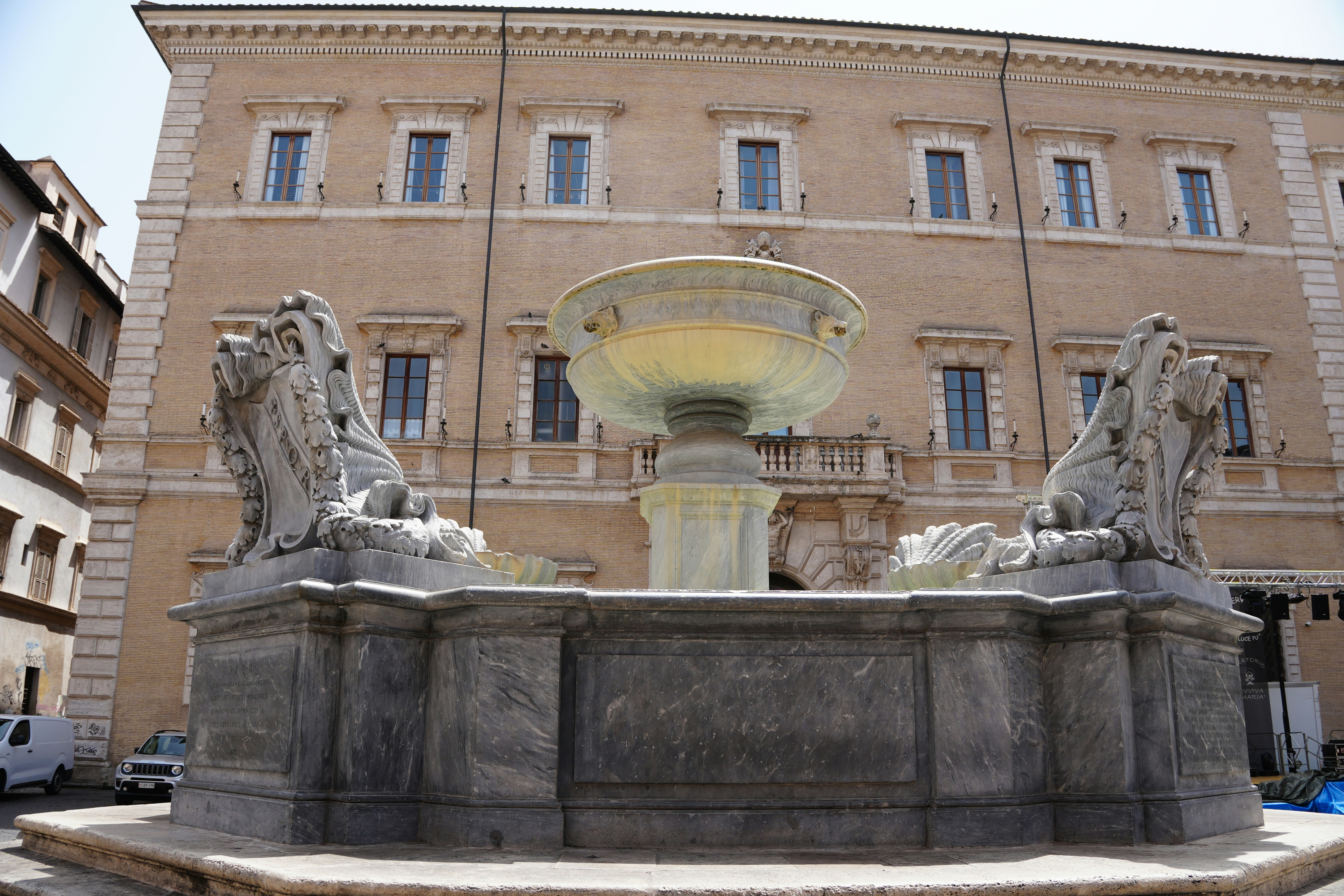 Central Fountain Framed by Historic Brick Facade