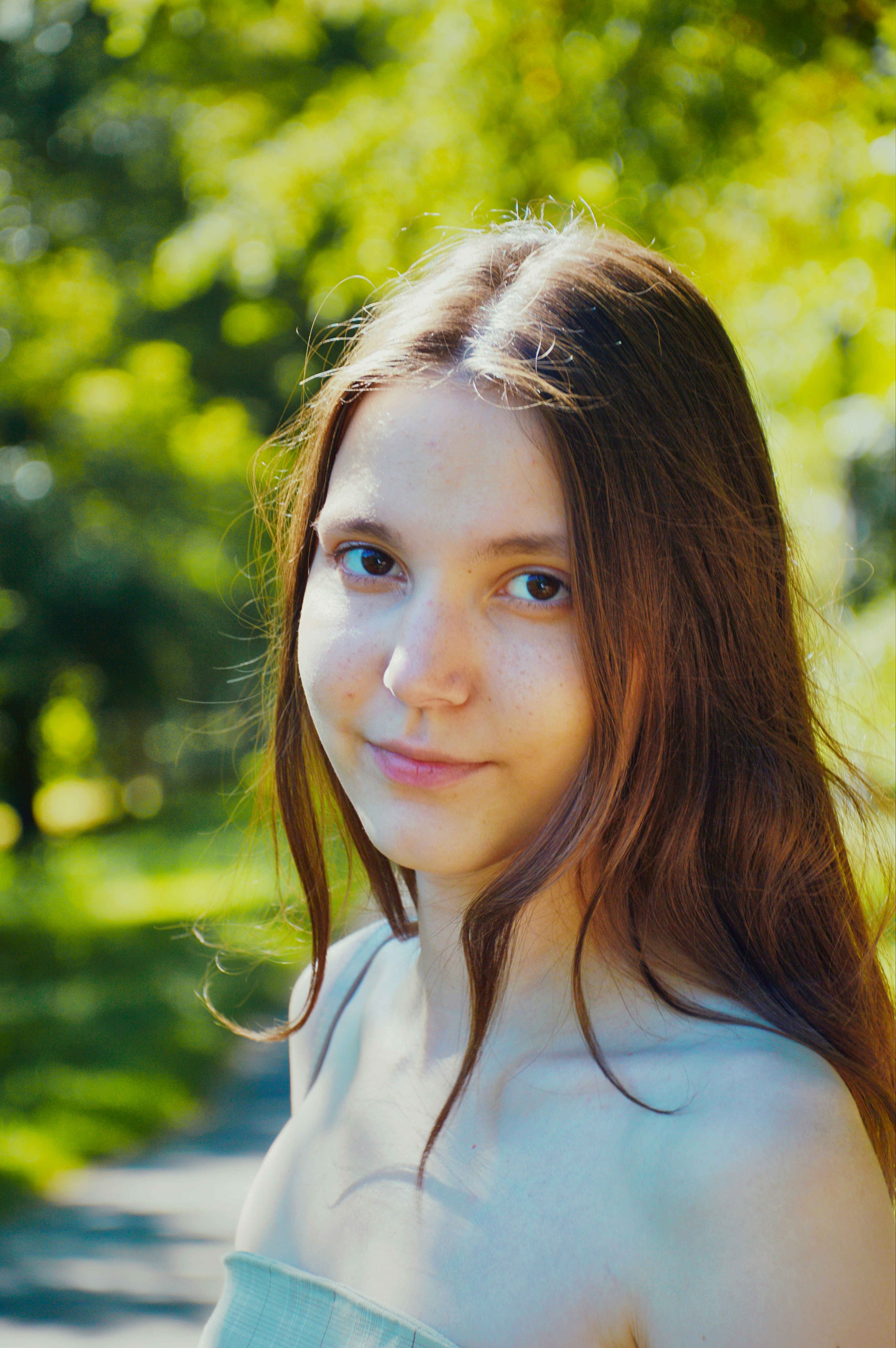 Soft Portrait in Sunlit Park: A Calm gaze and warm tones