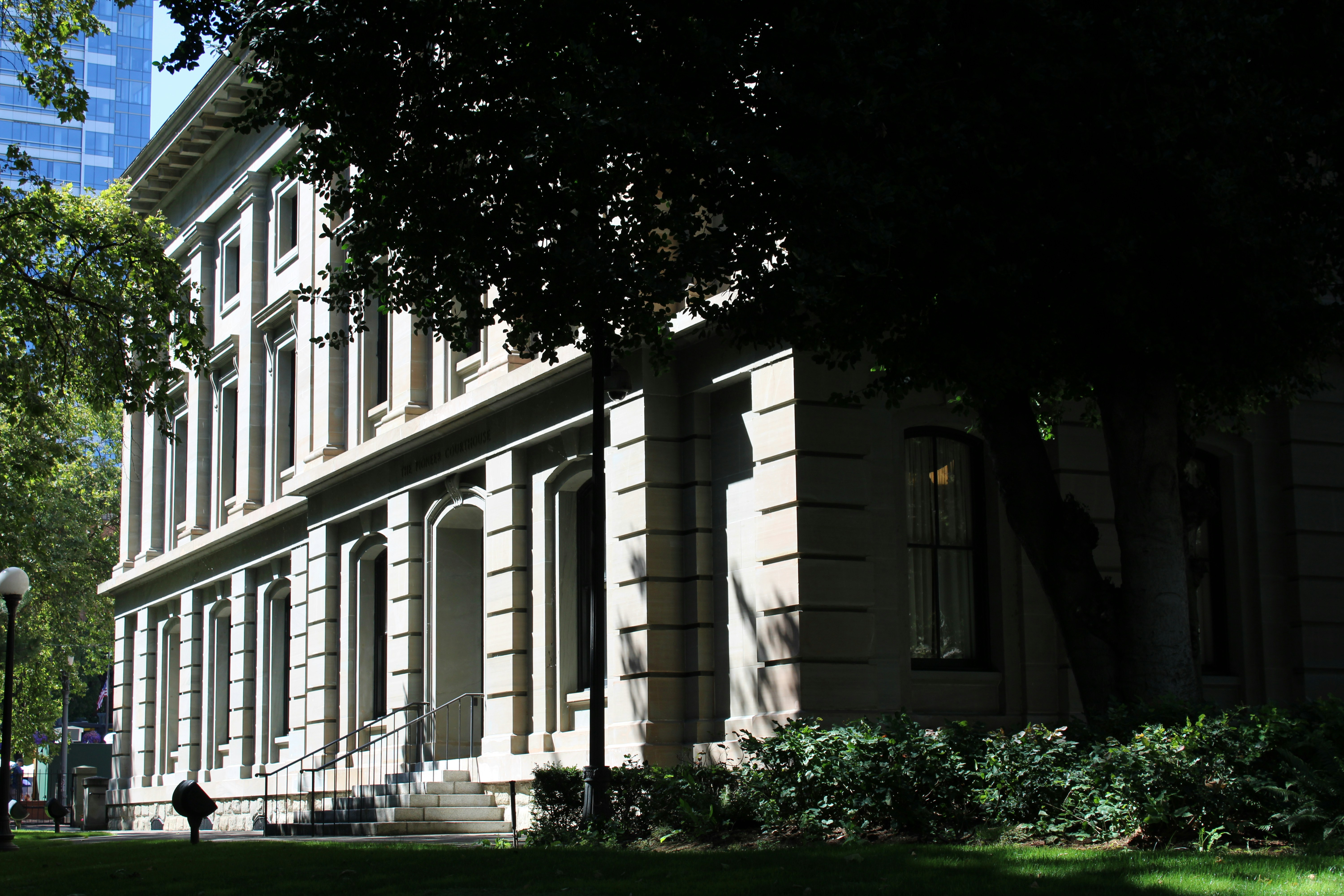 Sunlit Steps: A Classical Facade With Shadowed Lawnbank