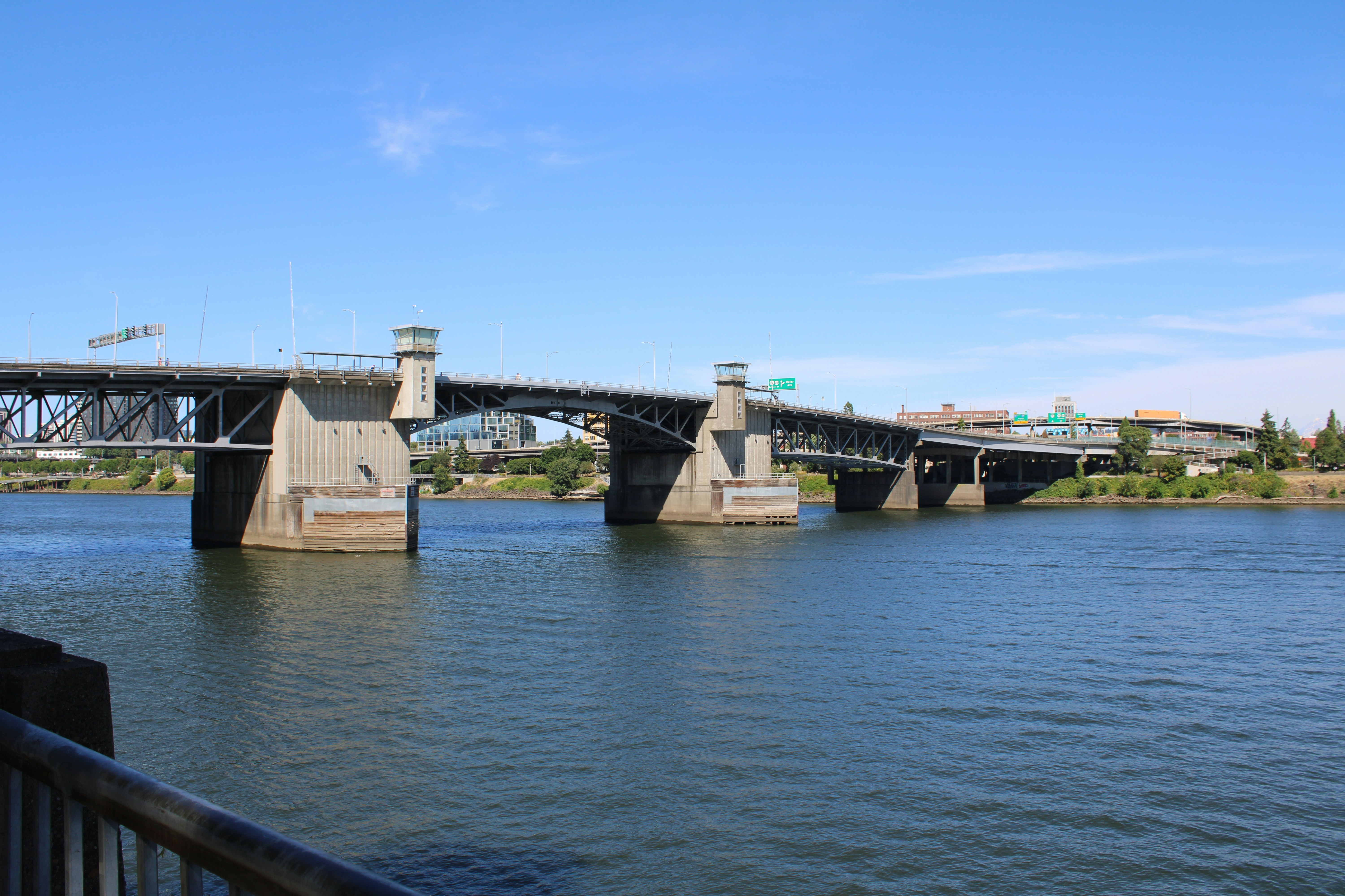 Riverspan overcast: A quiet city bridge in the afternoon sun
