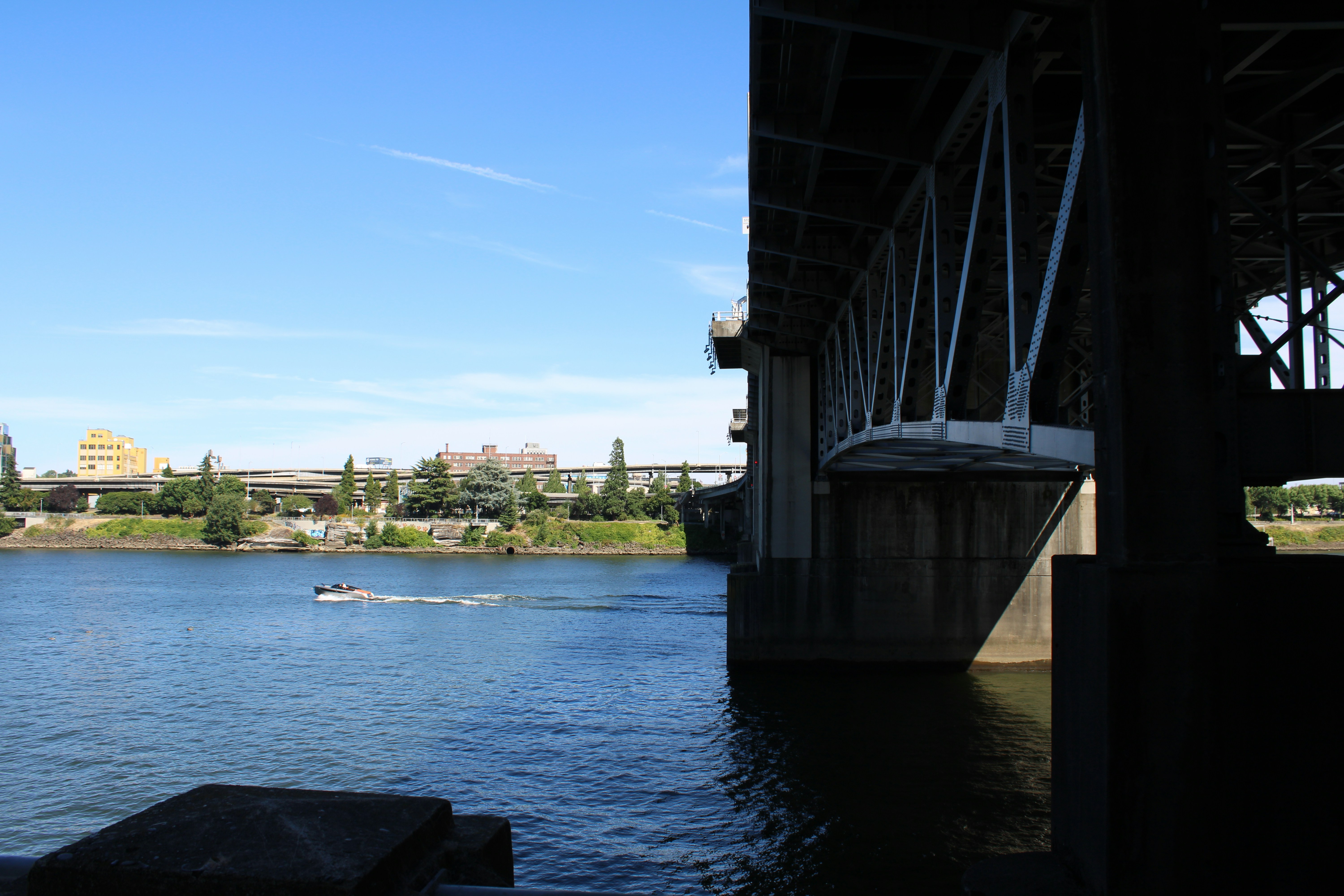 Shadowed Bridge Arches Over Quiet River