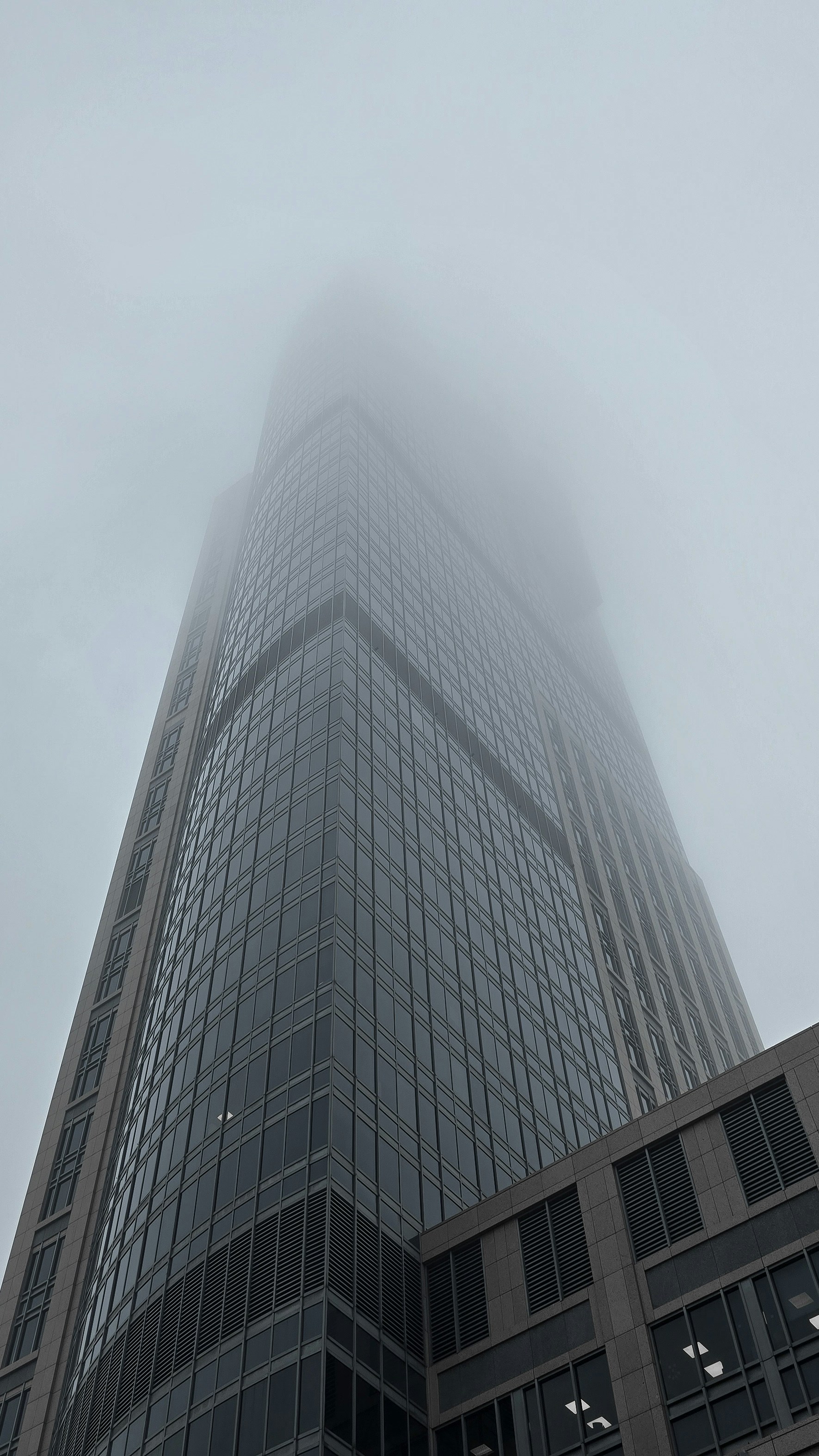 Shrouded Peak: A Glass Tower Reaches into the Mist