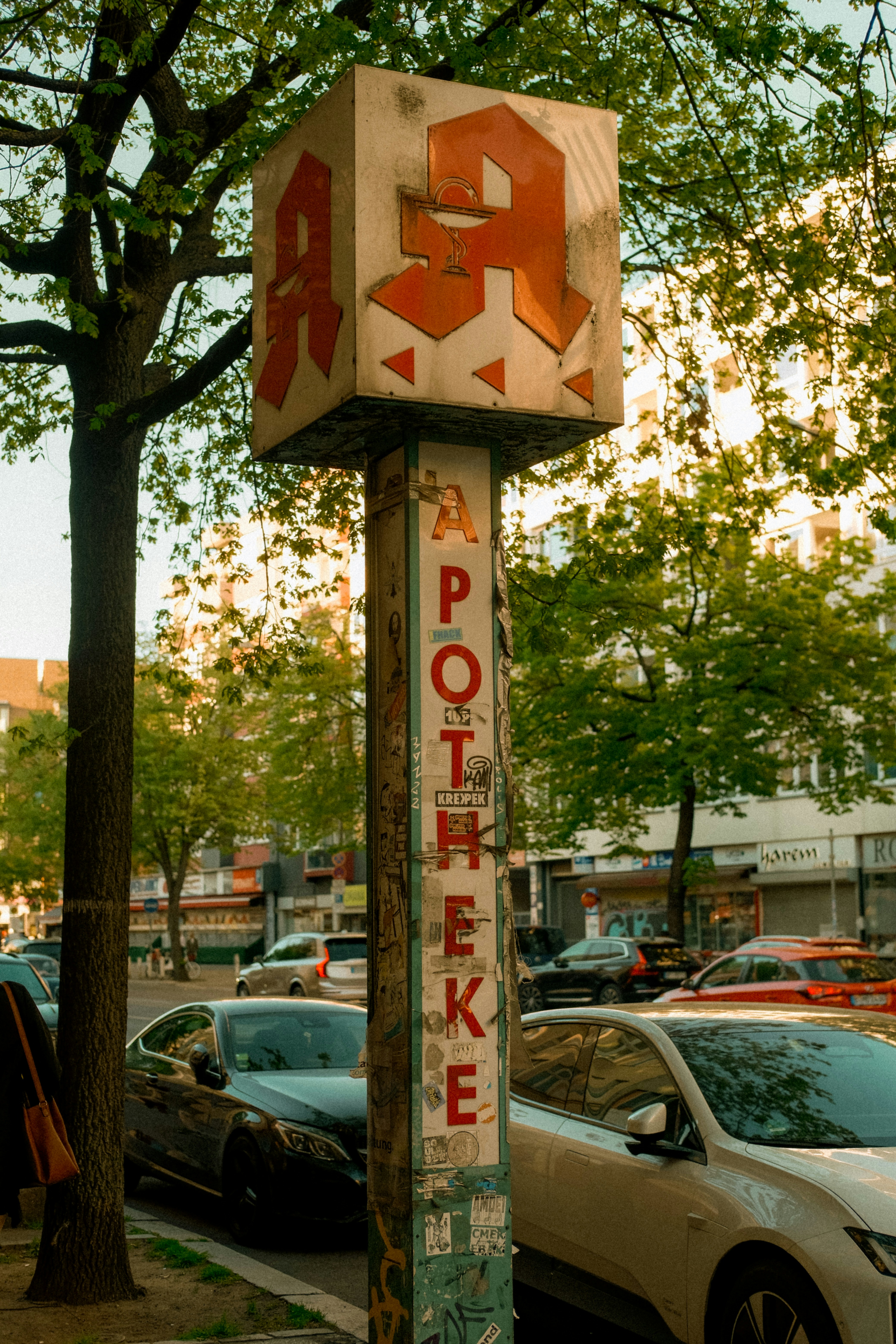 Neon Signpost on a Sunlit Urban Street