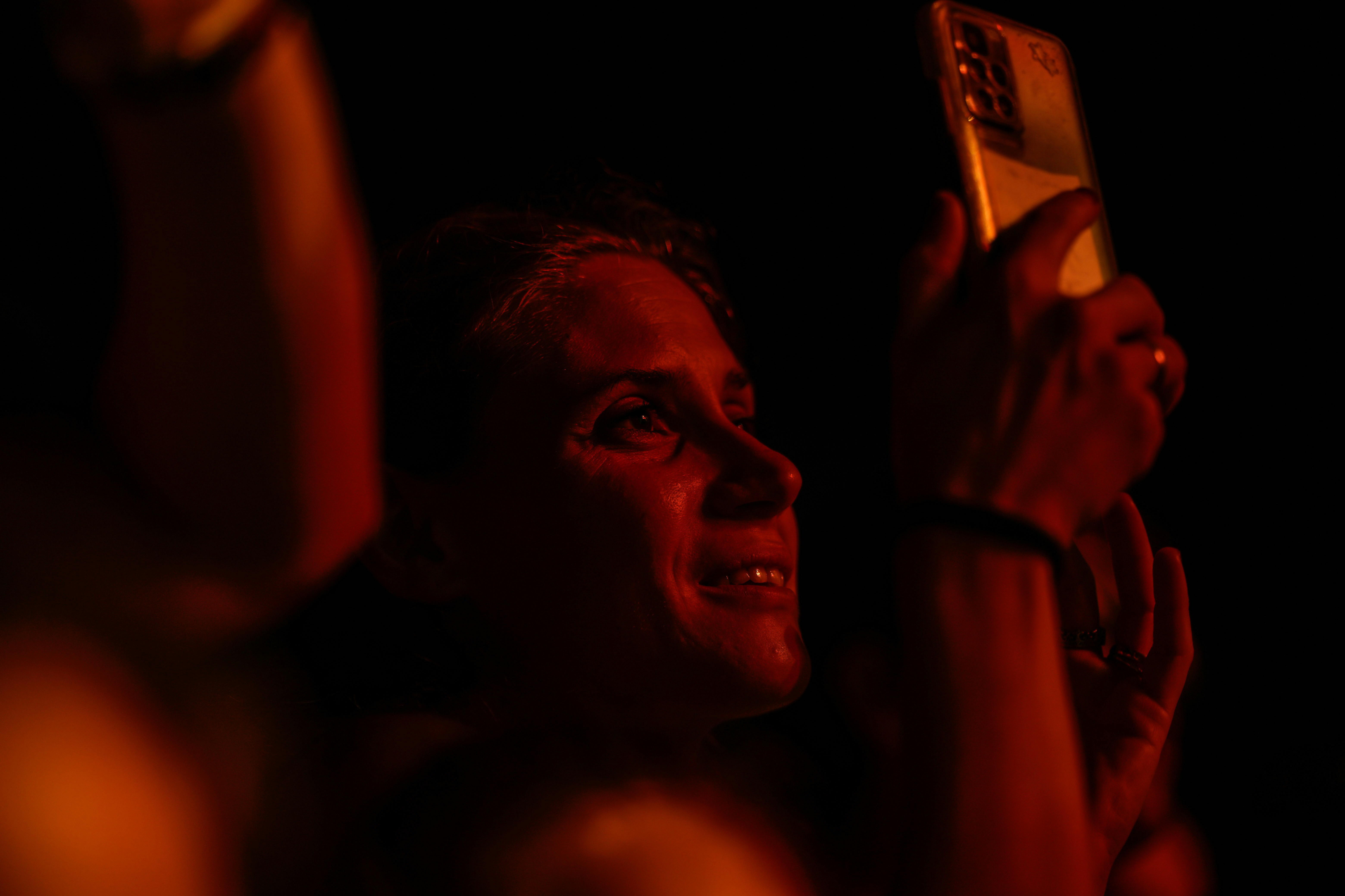 Midnight Pulse: A Crowd in Red Light Captures a Fan's Moment