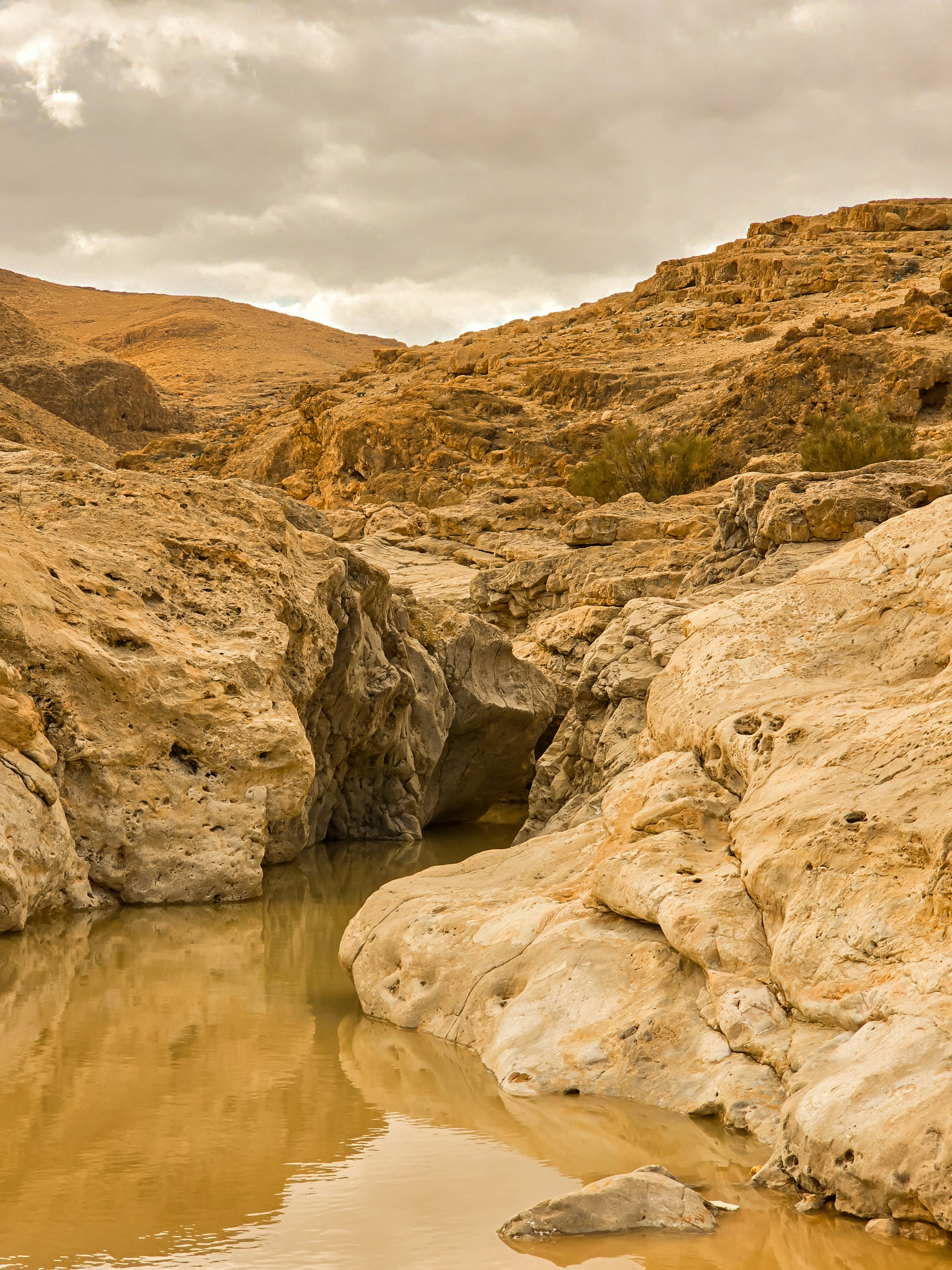 Desert Channel: Weathered Rocks Framing a Quiet Waterway