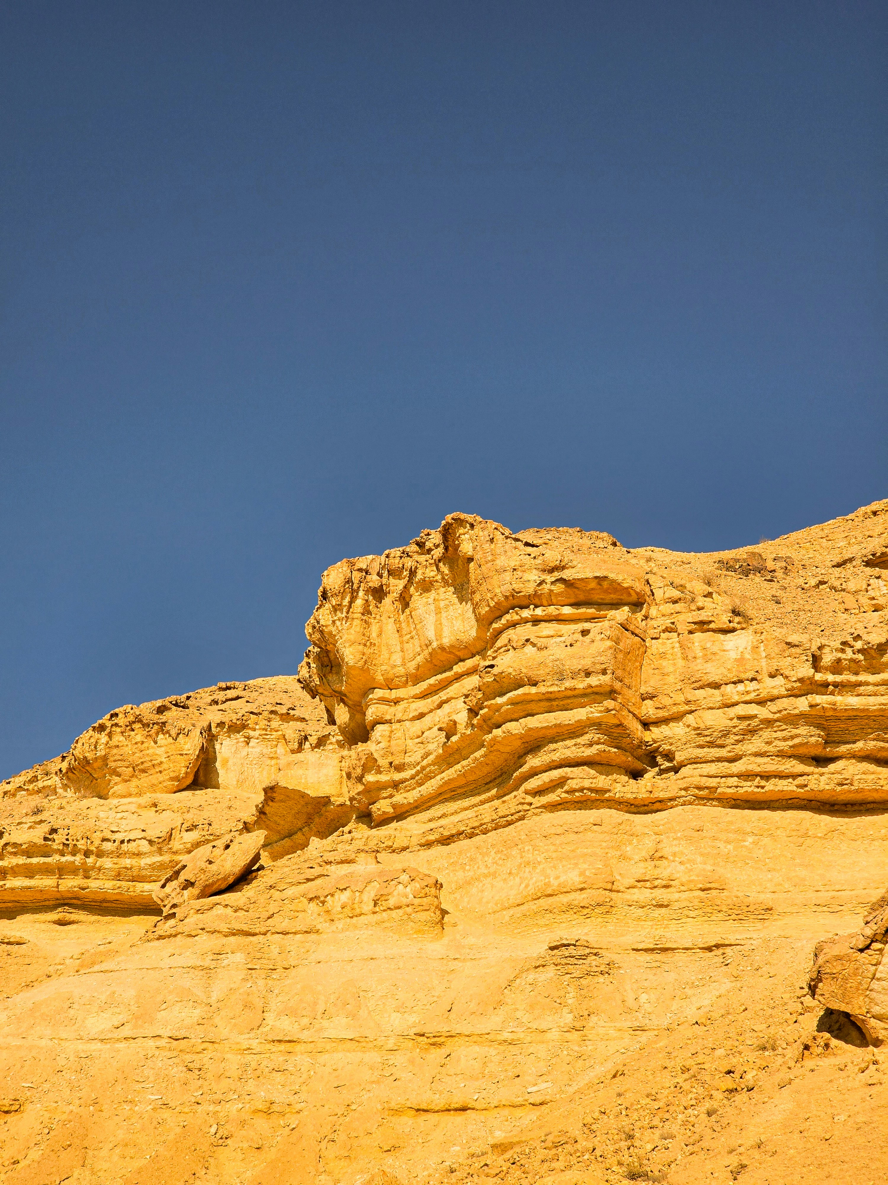 Golden Rock Formations Under a Clear Desert Sky