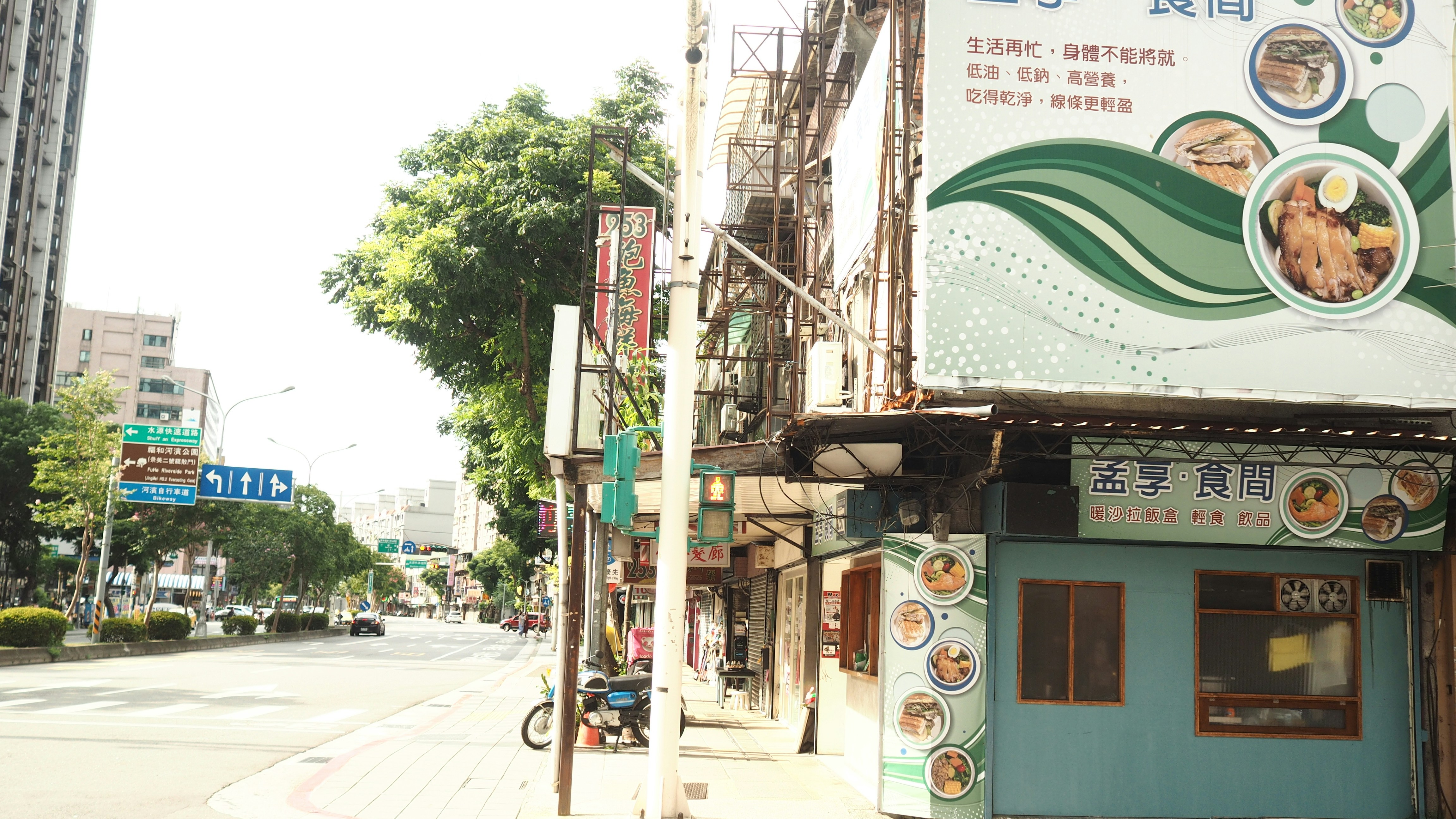 Quiet Chinatown Street with a Blue storefront and Food Signage