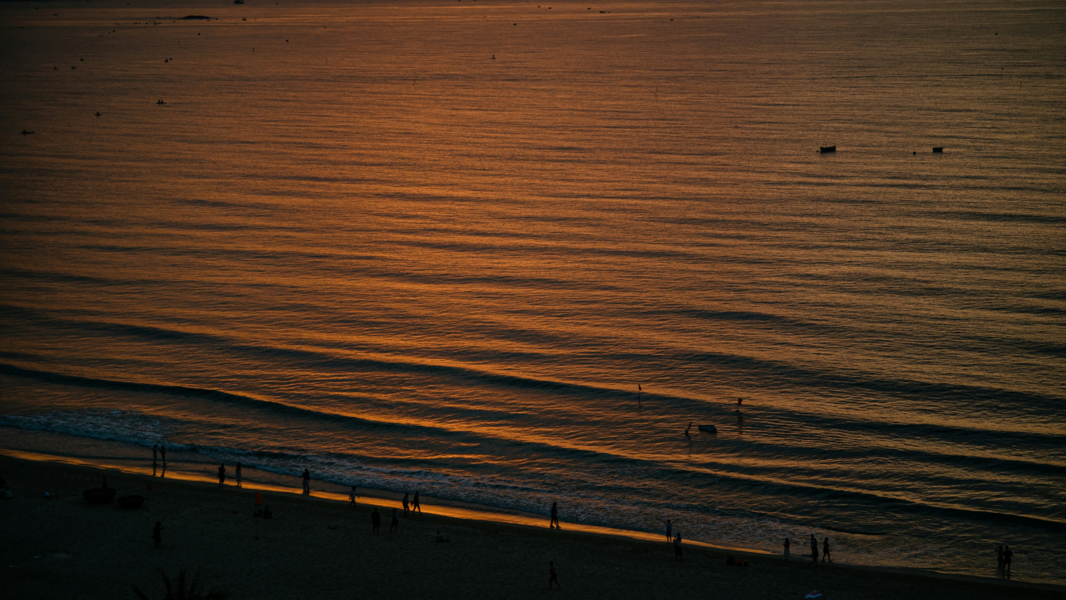 Golden Wave: A Quiet Sunset Over Distant Shore