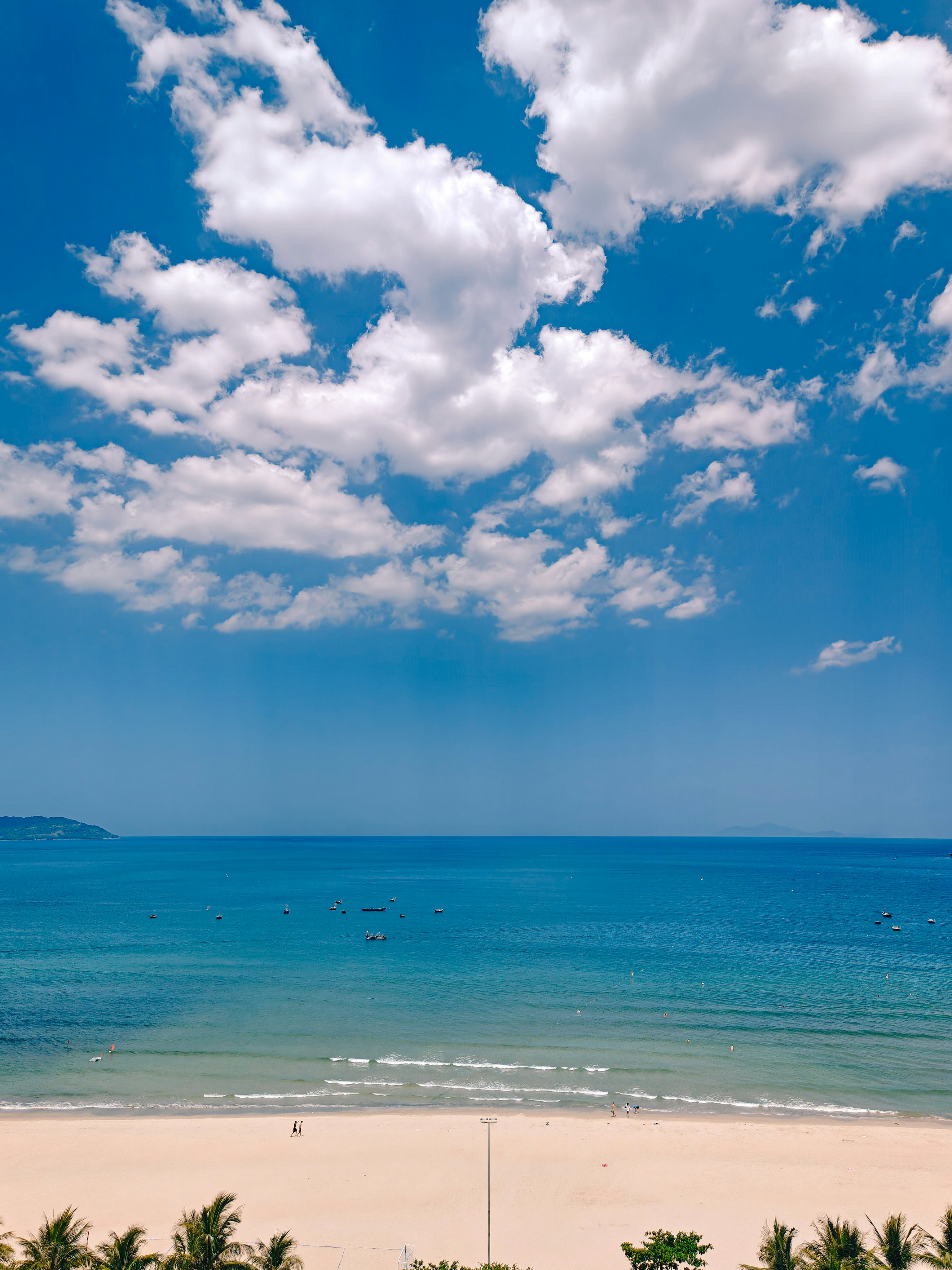 Coastal Canvas: Clouds, Sea, and Sand Align in Quiet Symmetry
