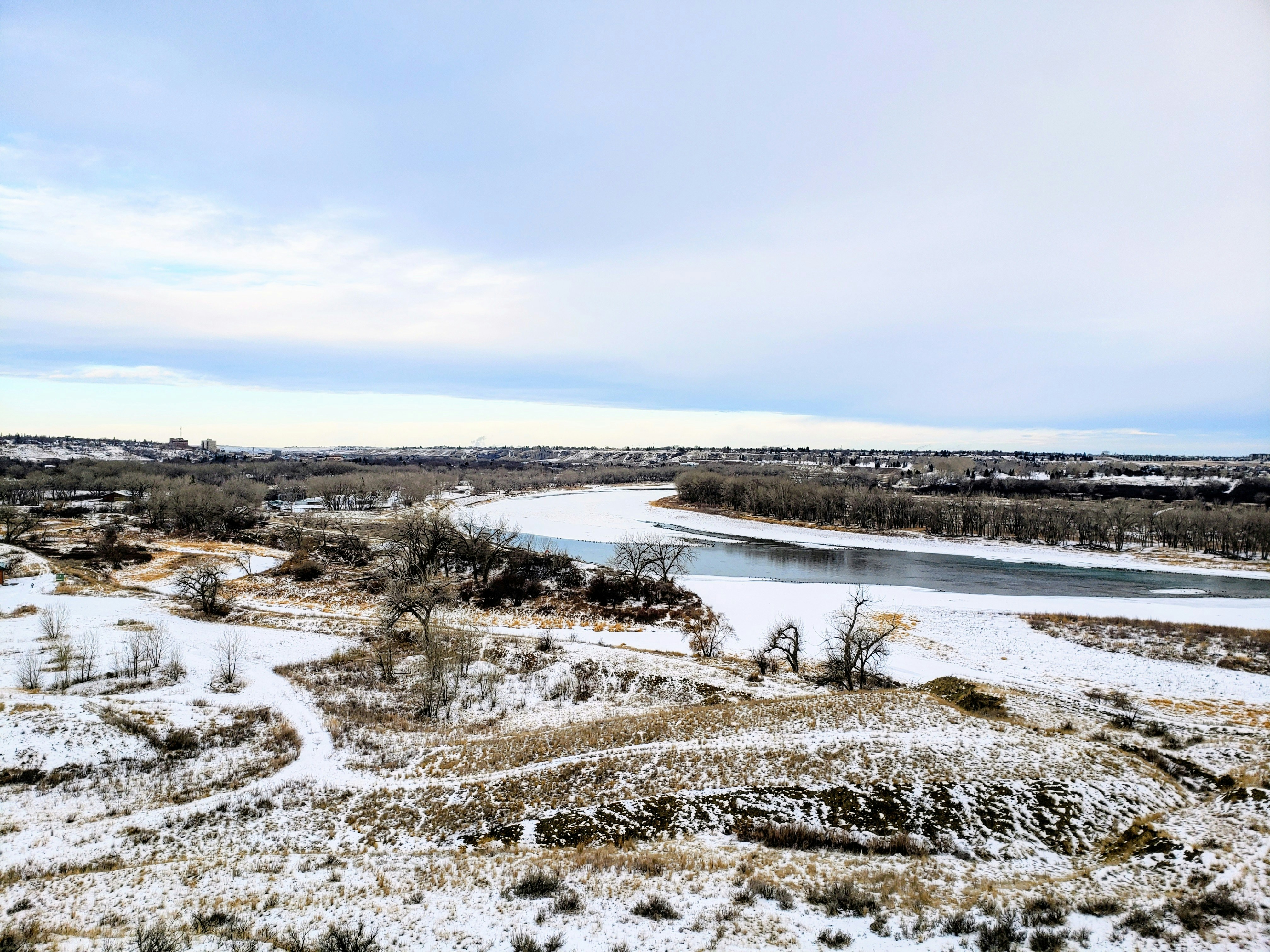 Snow-White River Bend Under Vast Winter Sky