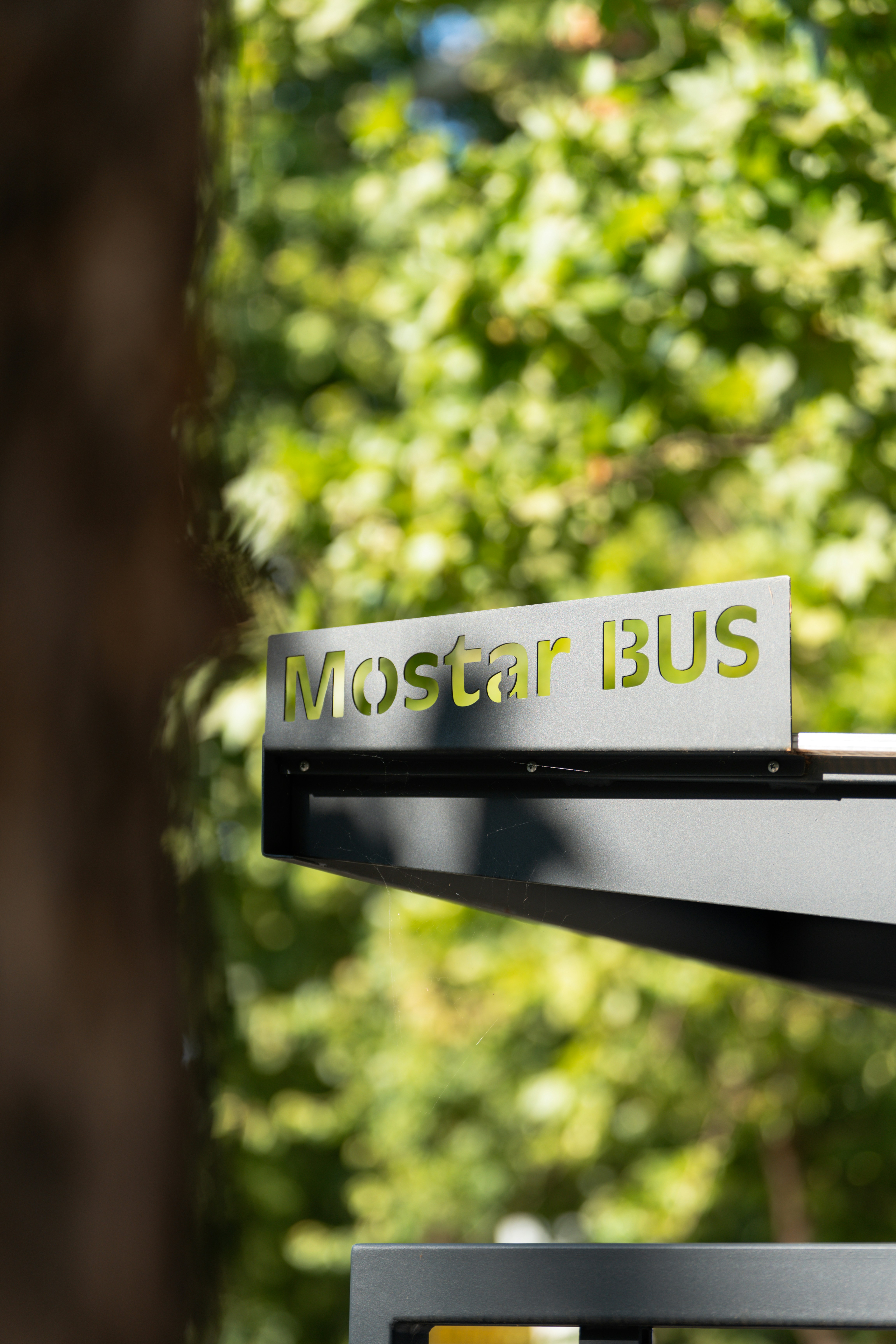 Steel Sign at a Sunlit Bus Stop